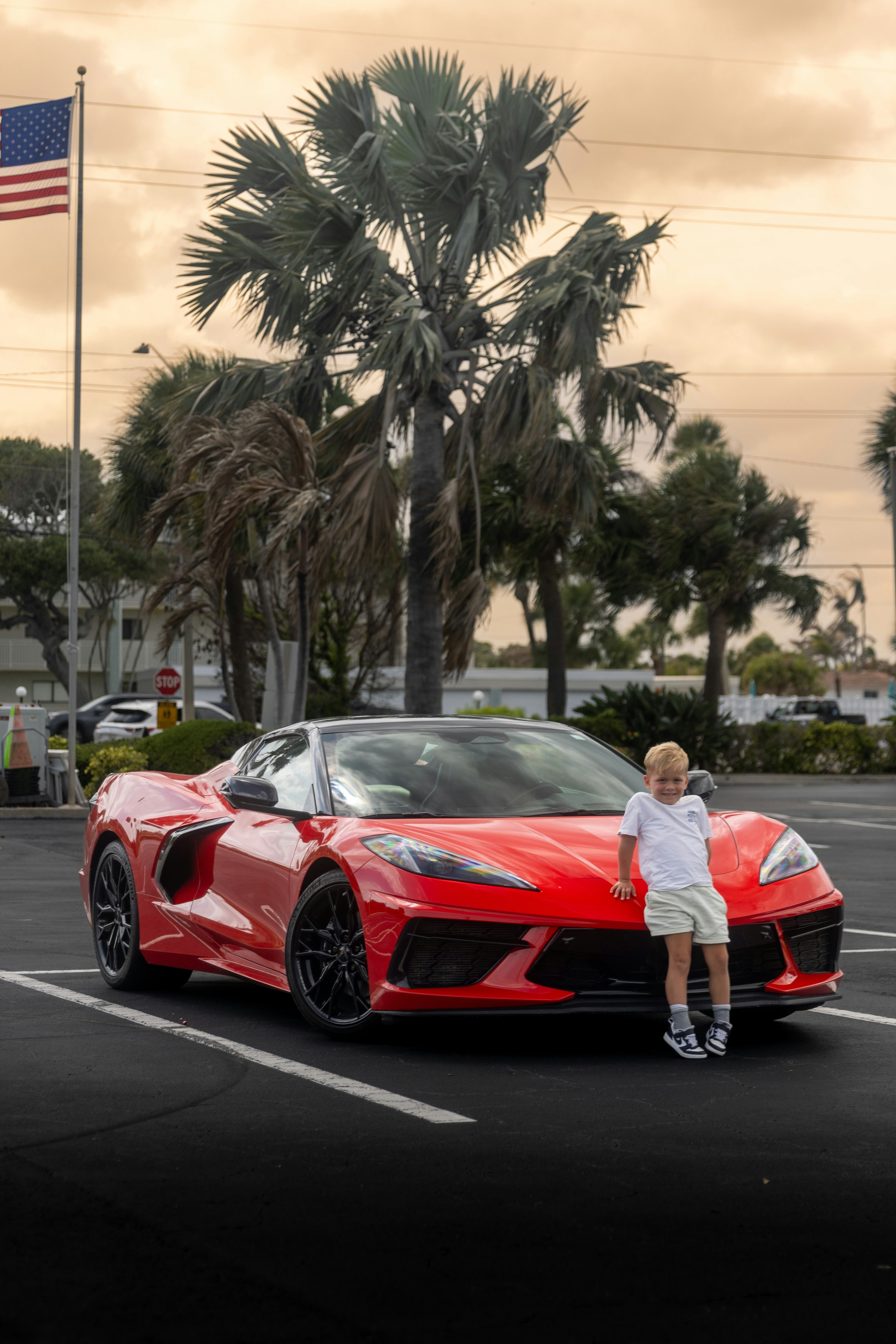 Red Convertible in a Golden Sunset: A Kid's Moment by the Car