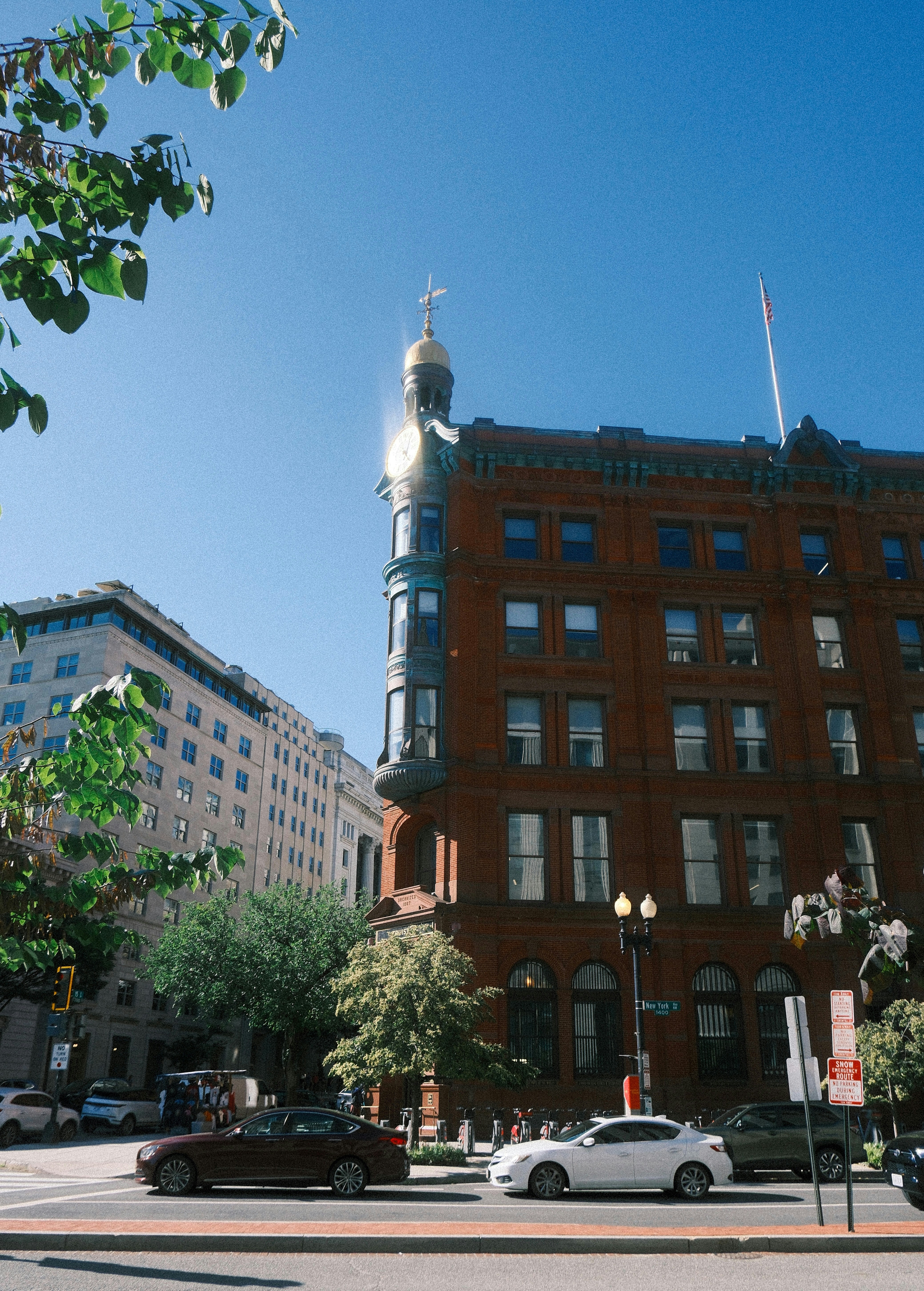 Cornerstone of Red Brick: A Turreted City Block Rising Between Street and Sky