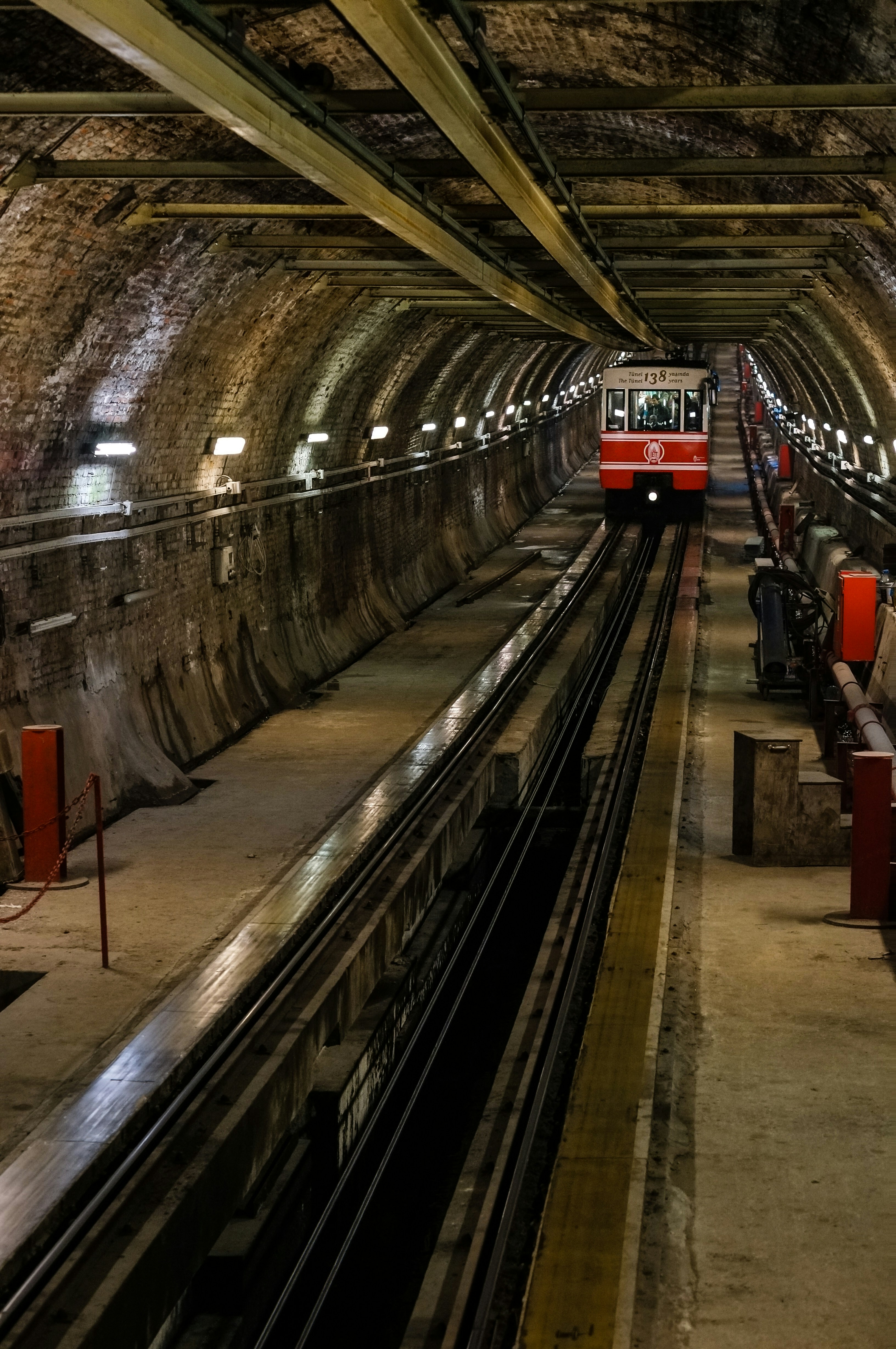 Underground Rail in Focus: A Red Car Traverses the Tunnel Arc