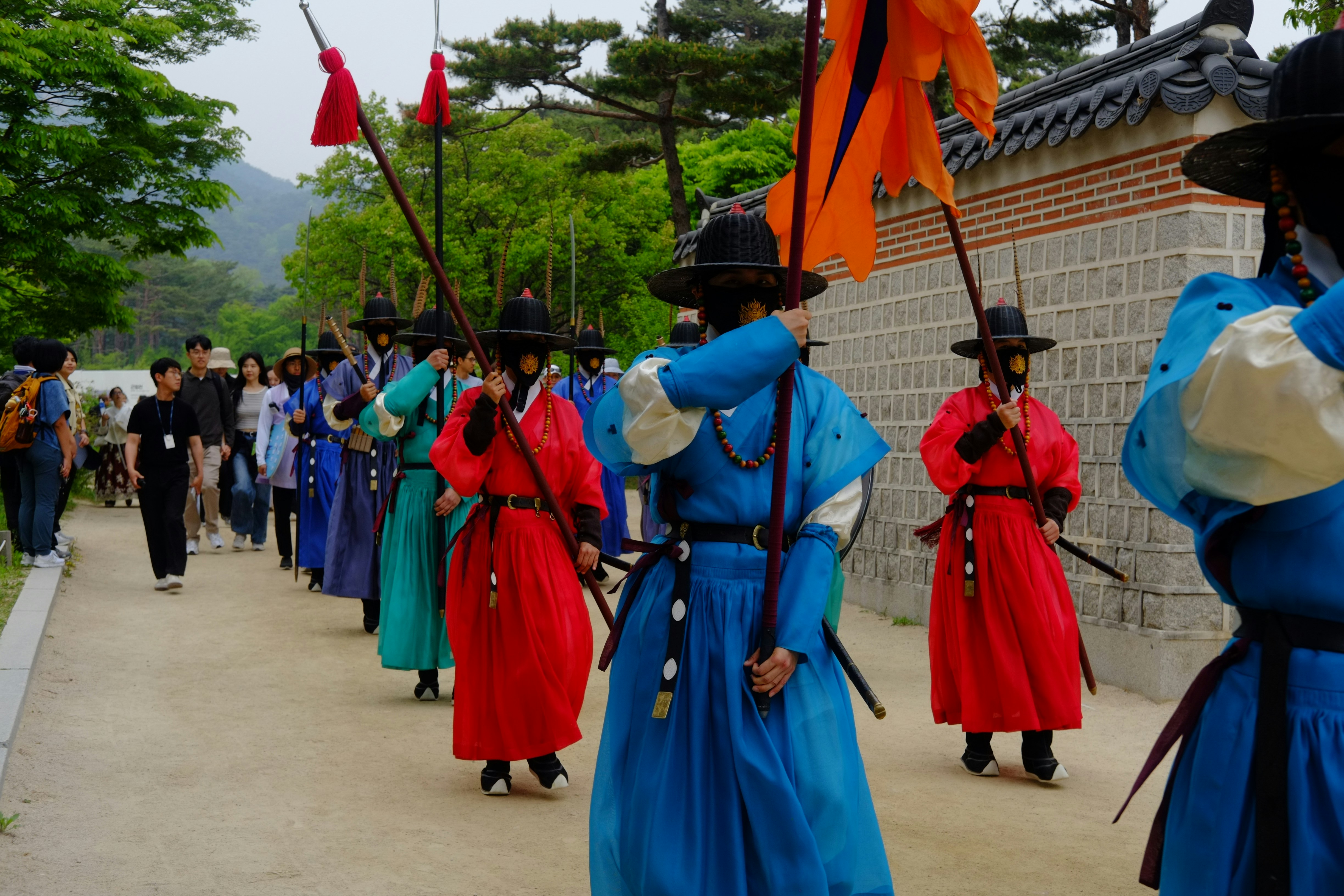 Ceremonial Guards in Colorful Hanbok-Style Attire Parade at the Wall