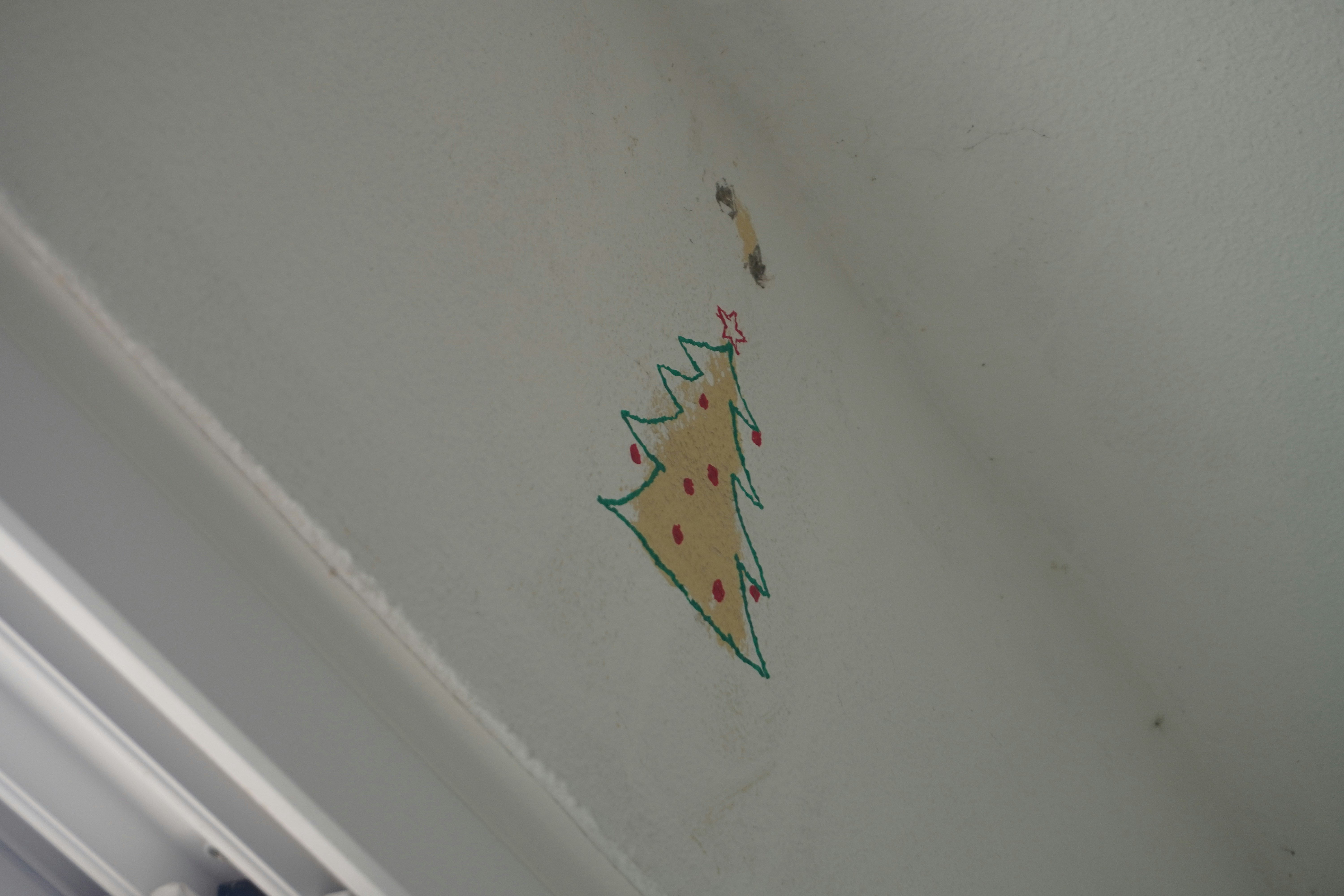 Minimal Christmas Wall Sketch on Pale Surface