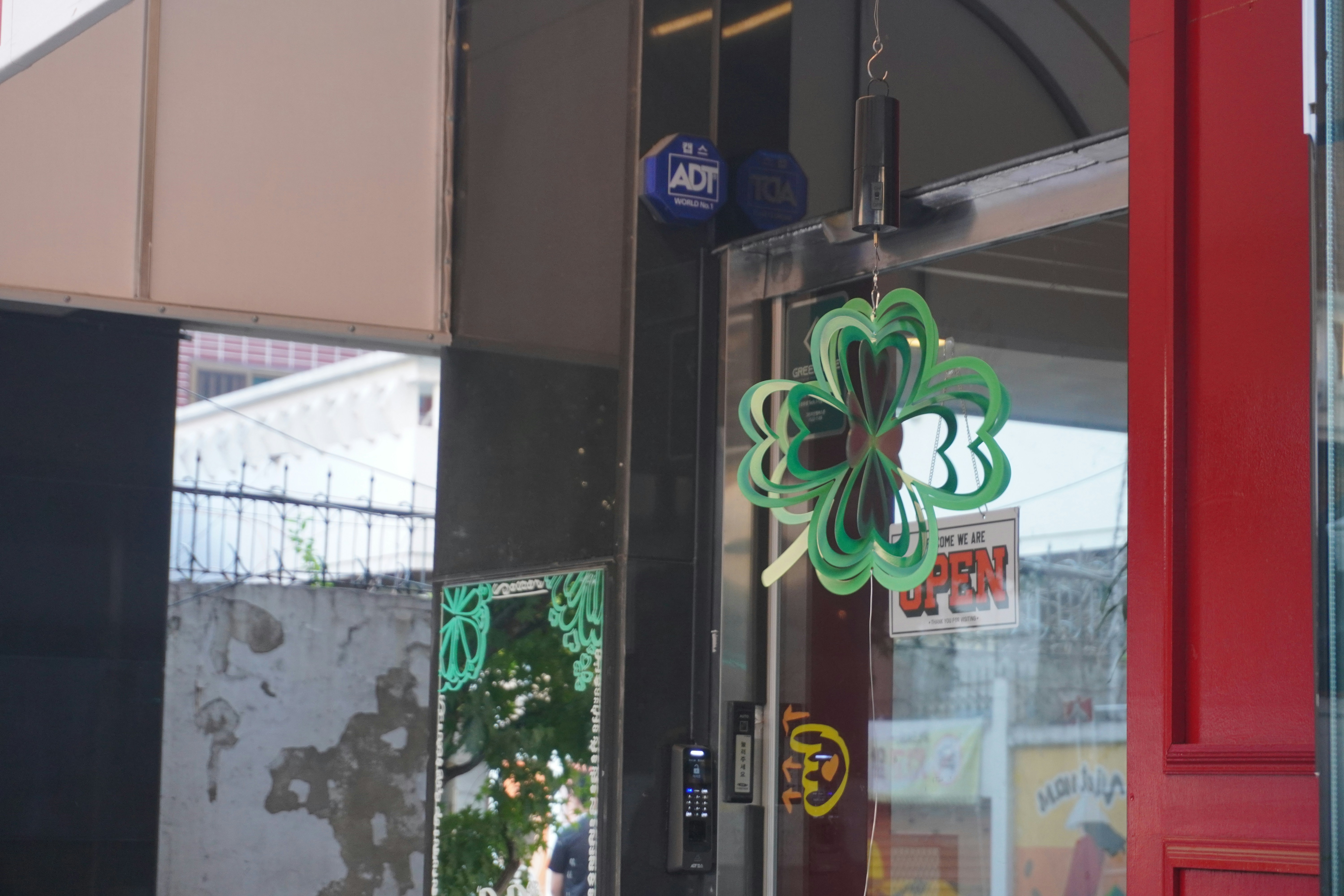 Green Clover Ornament at a Modern Storefront