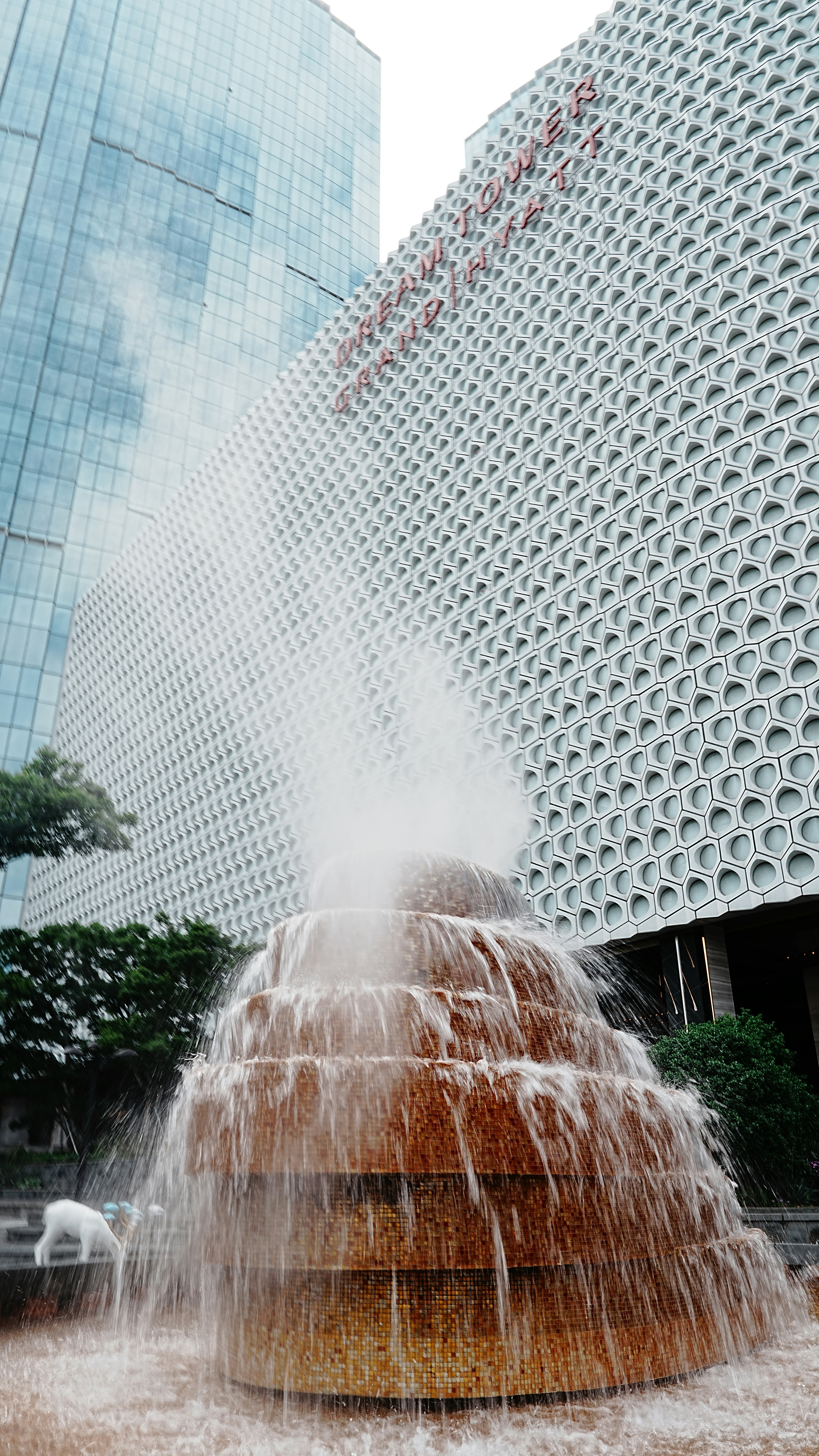 Fountain Bloom Before a Modern Façade