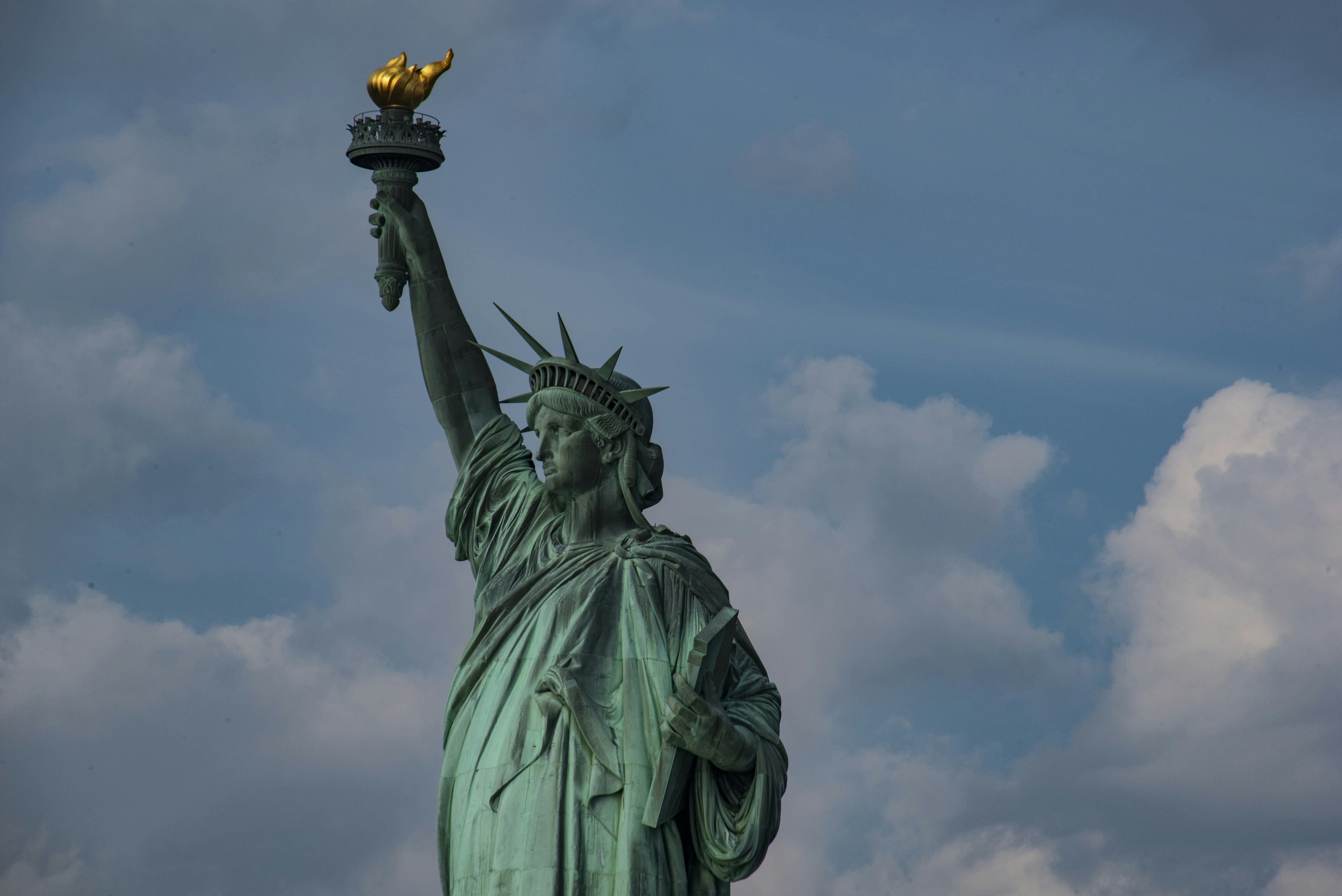 Statue of Liberty against a Sky of Blue and Clouds