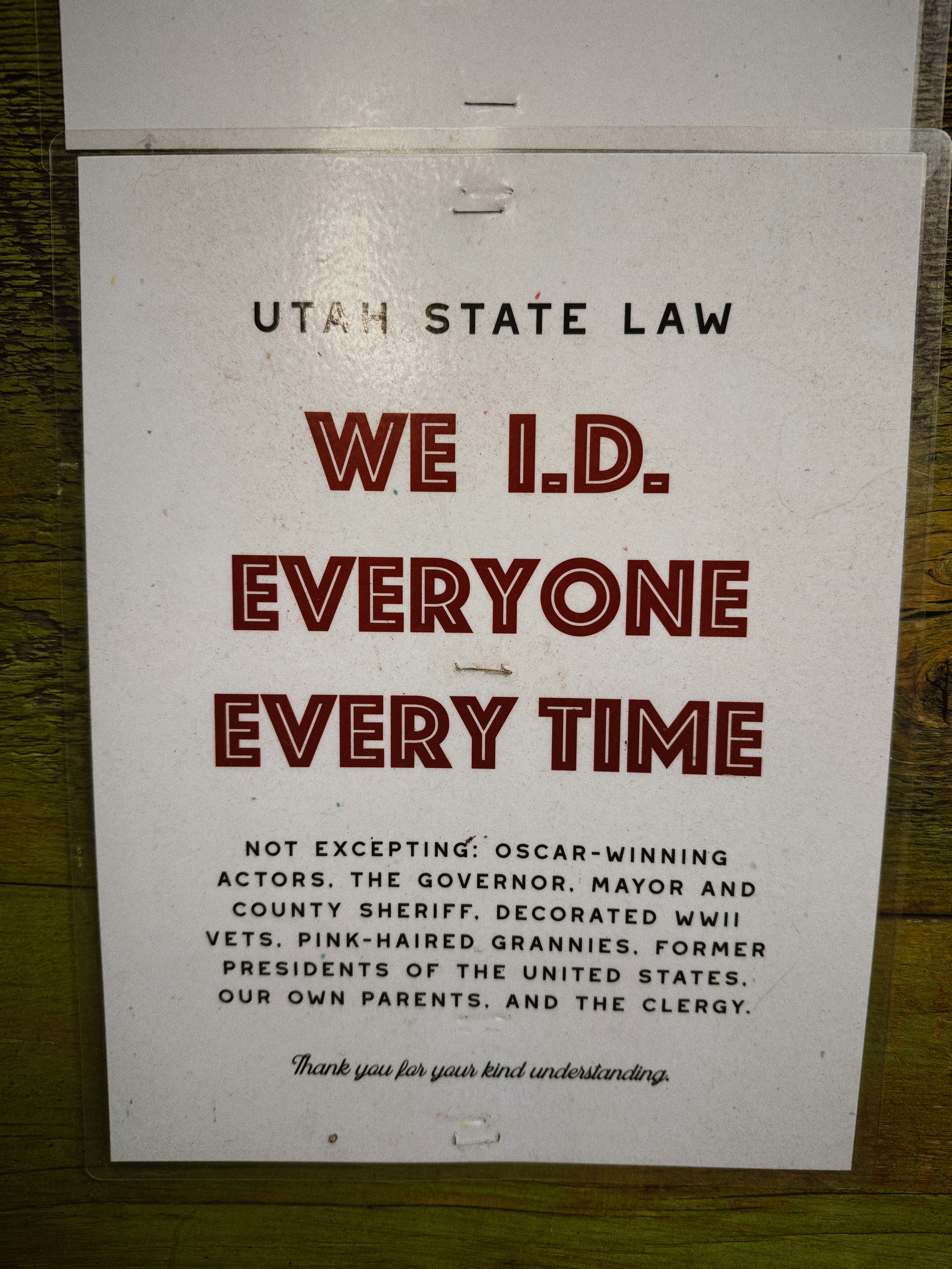 Utah state law sign: we i.d. everyone every time.