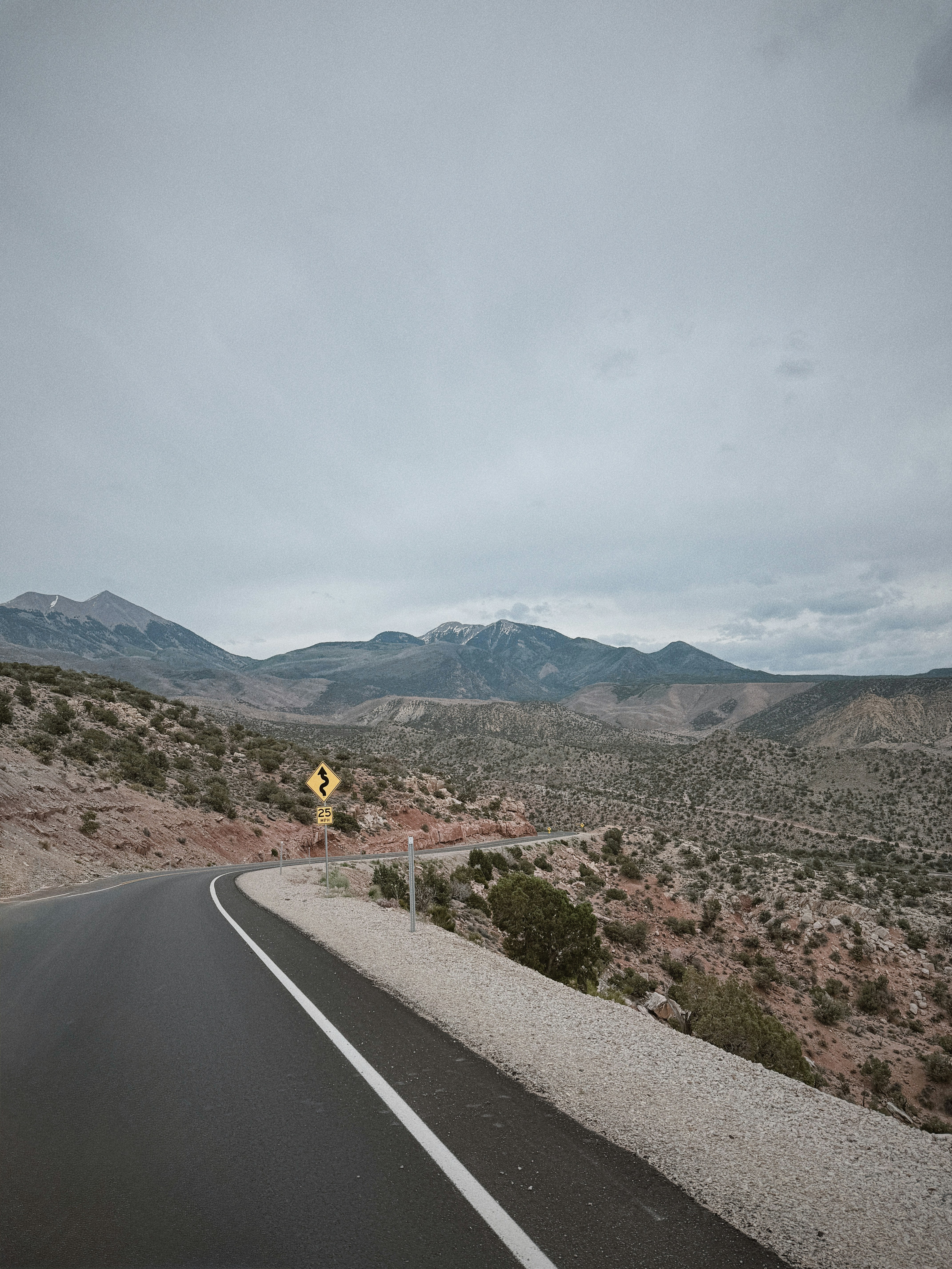 Desert Highway Bends Toward Distant Peaks