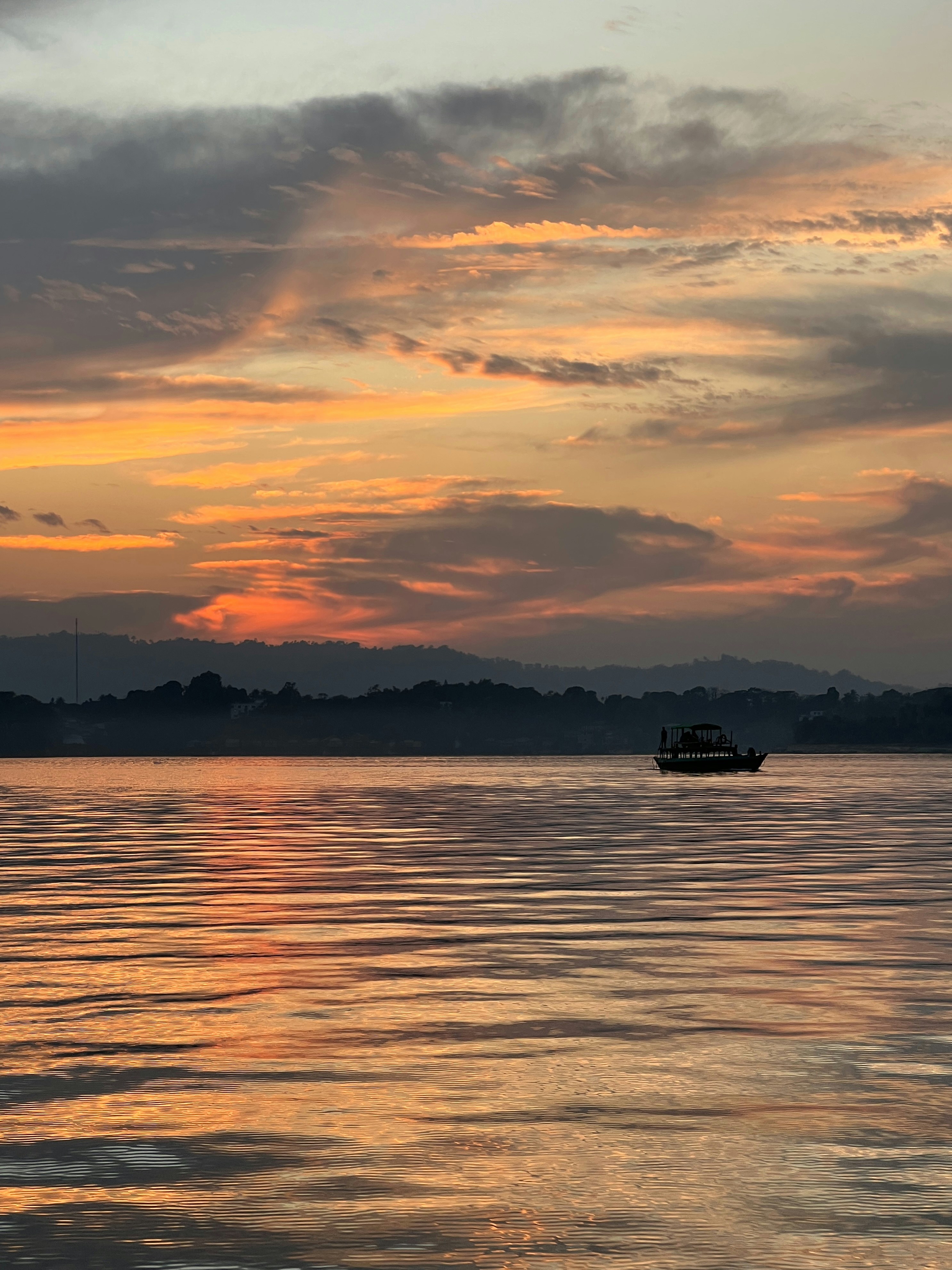 Silhouette Boat at Sunset Between Quiet Horizons
