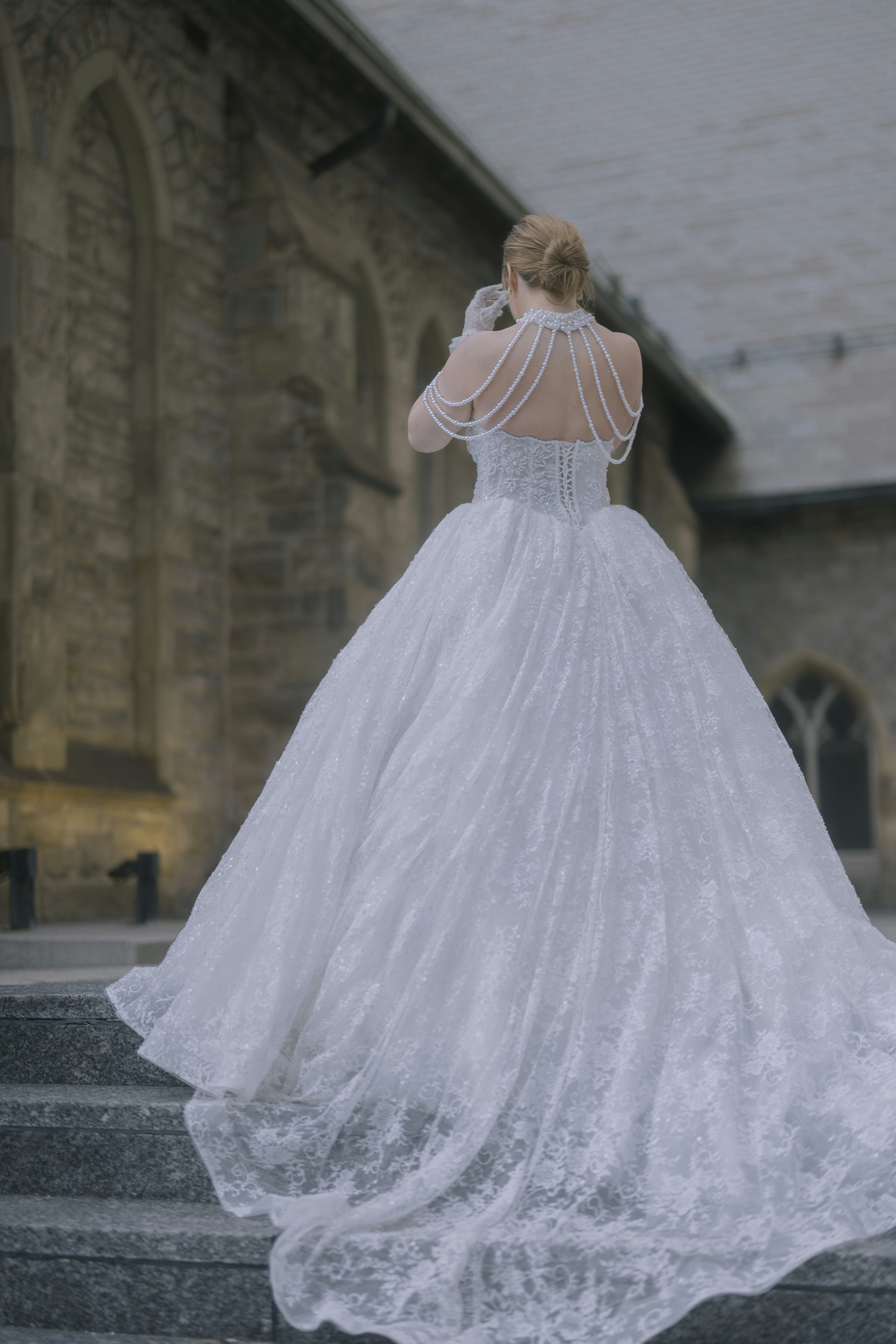 Luxurious ascent: bridescape atop stone stairs against the cathedral backdrop