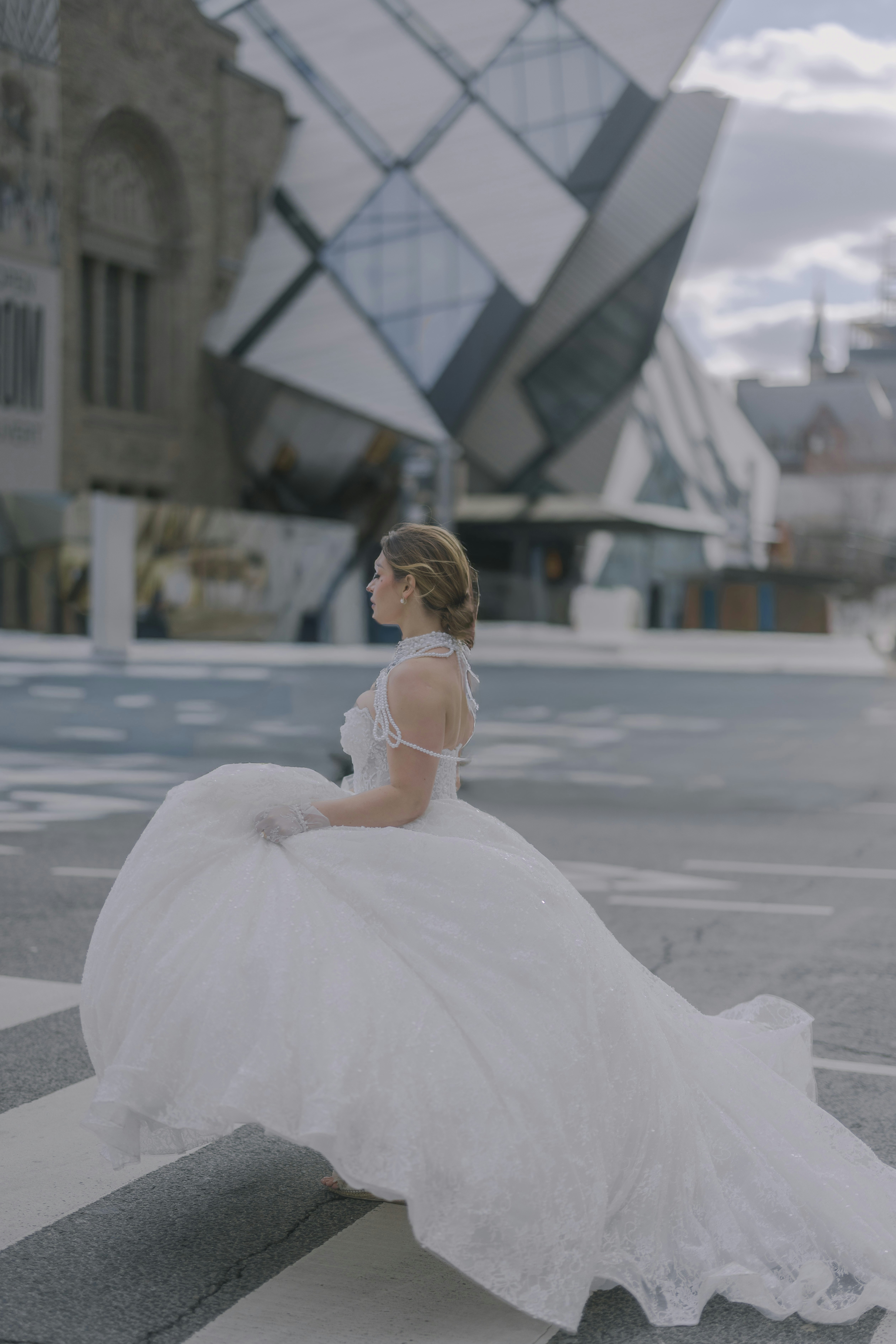 Bride in a Flowing Gown Crossing an Urban Palette