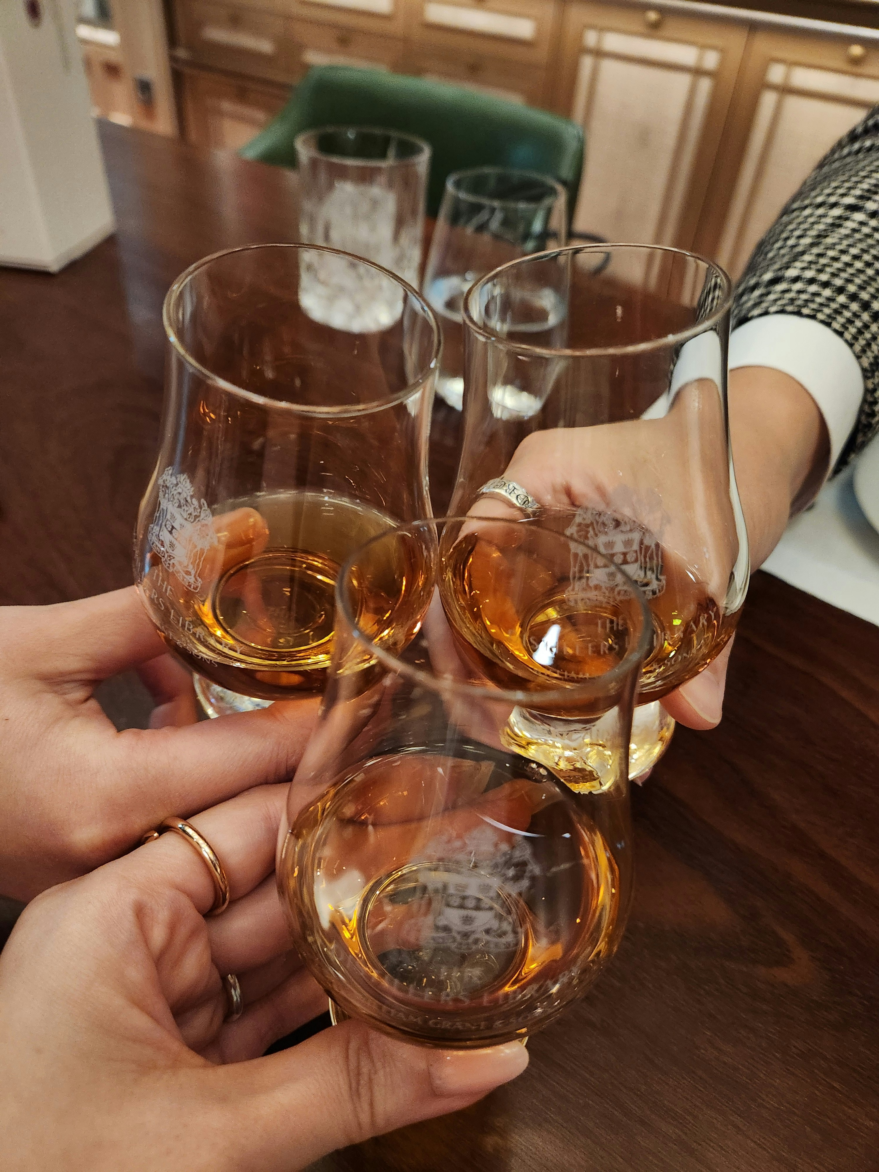 Toast Across the Table: Glasses Clink in a Warm Bar Setting