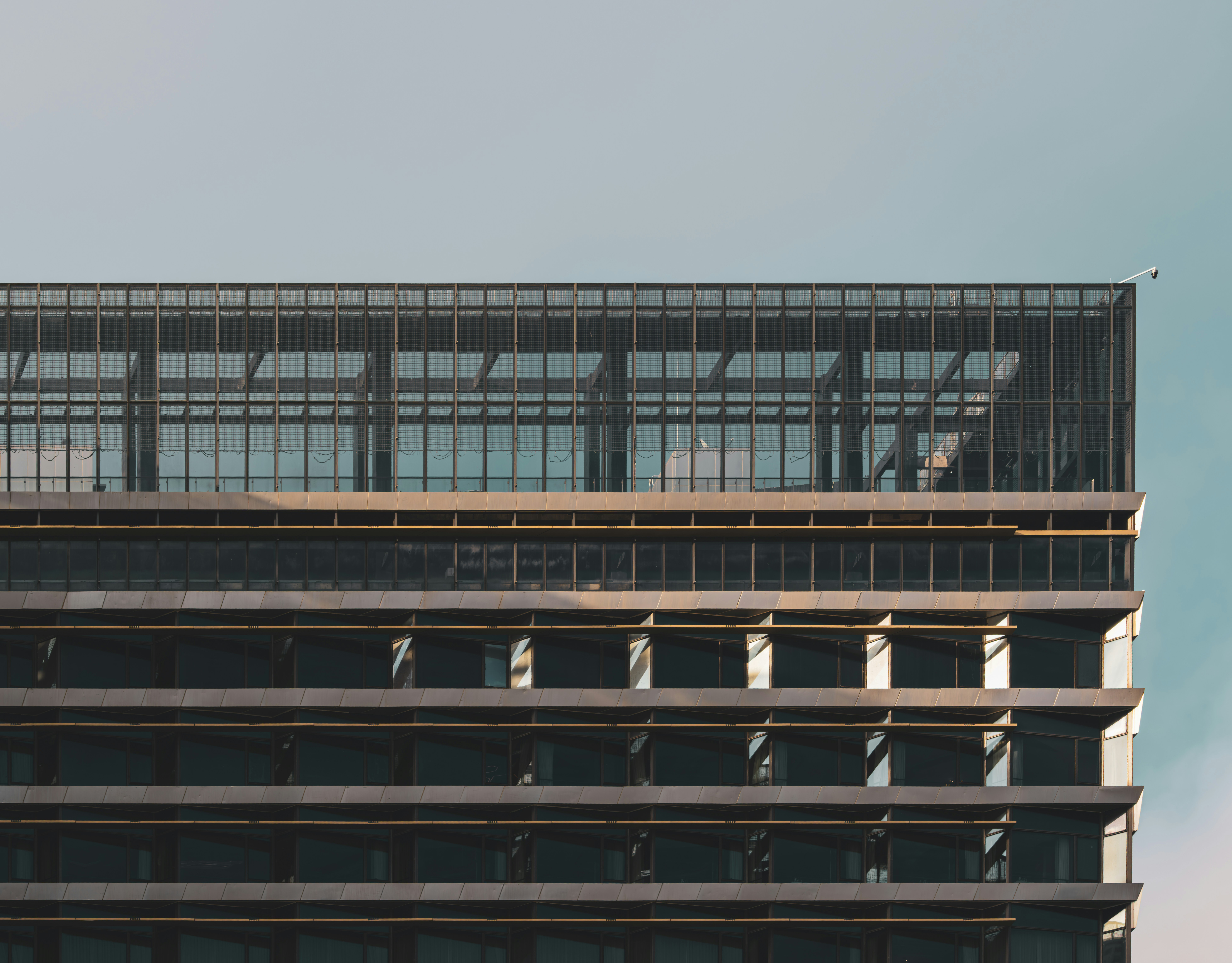 Modern building with glass windows against a clear sky.