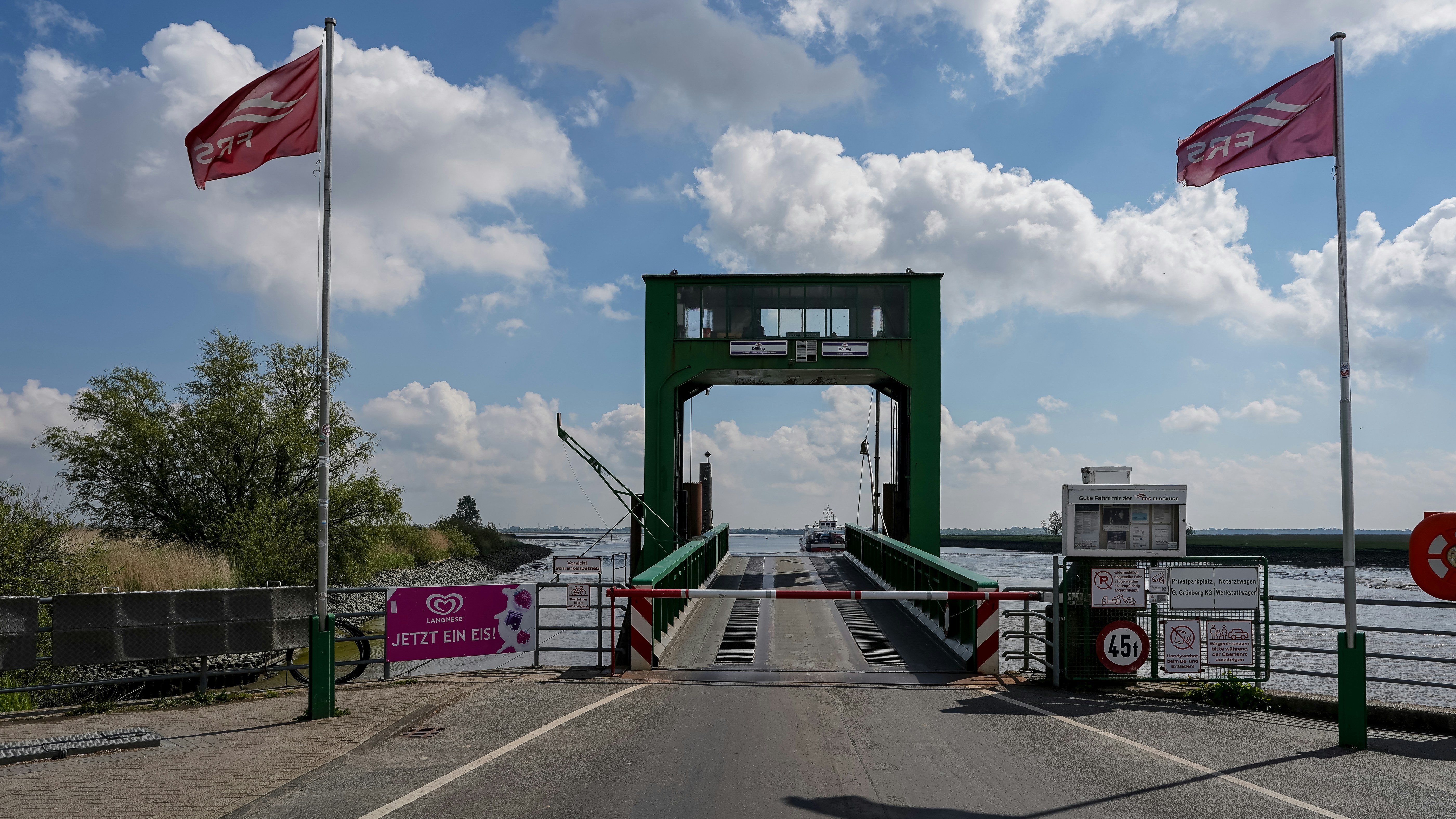 Gateway to the Water: A Green Drawbridge Over Calm Seas