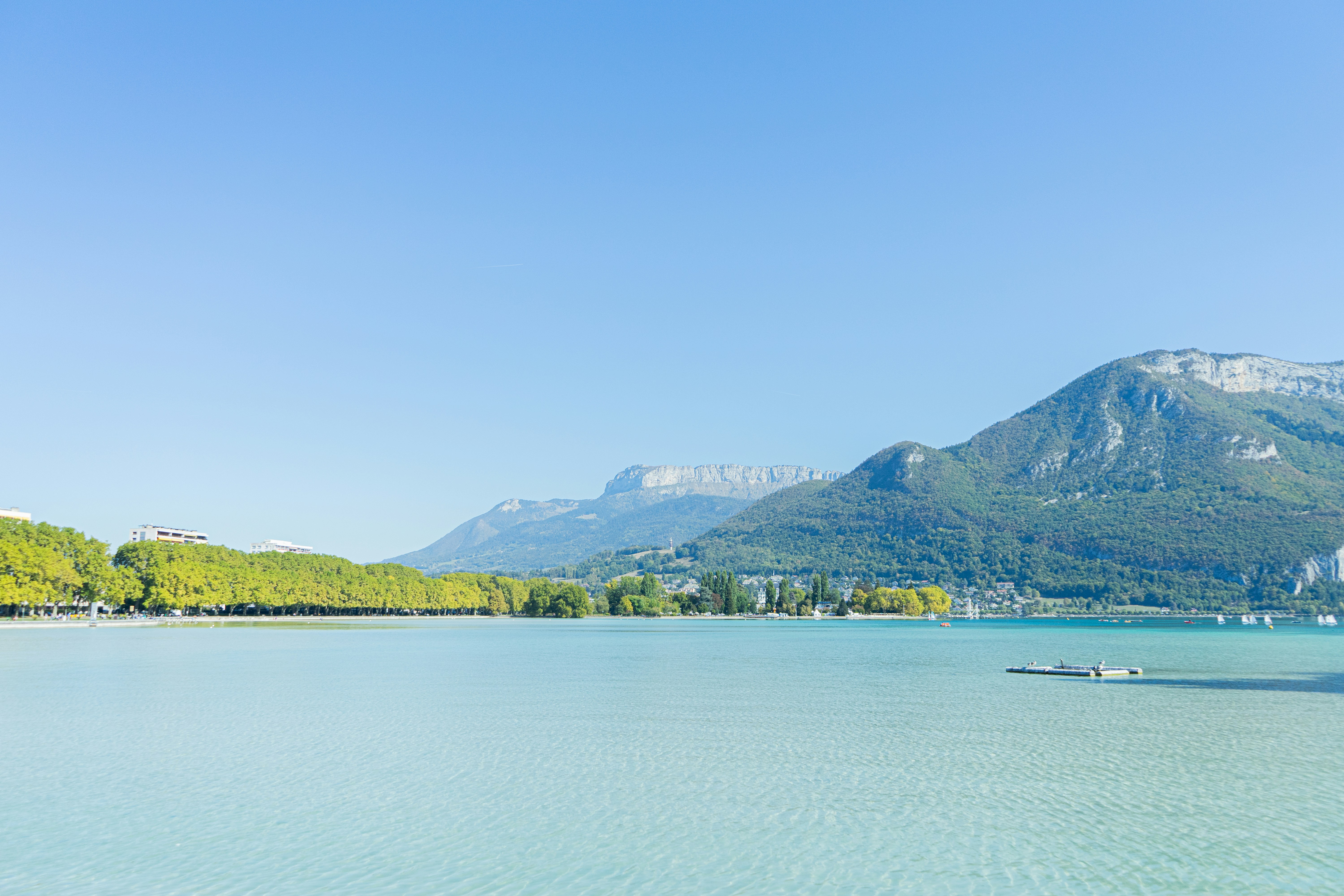 Serene Lakefront with Distant Alpine Ridge