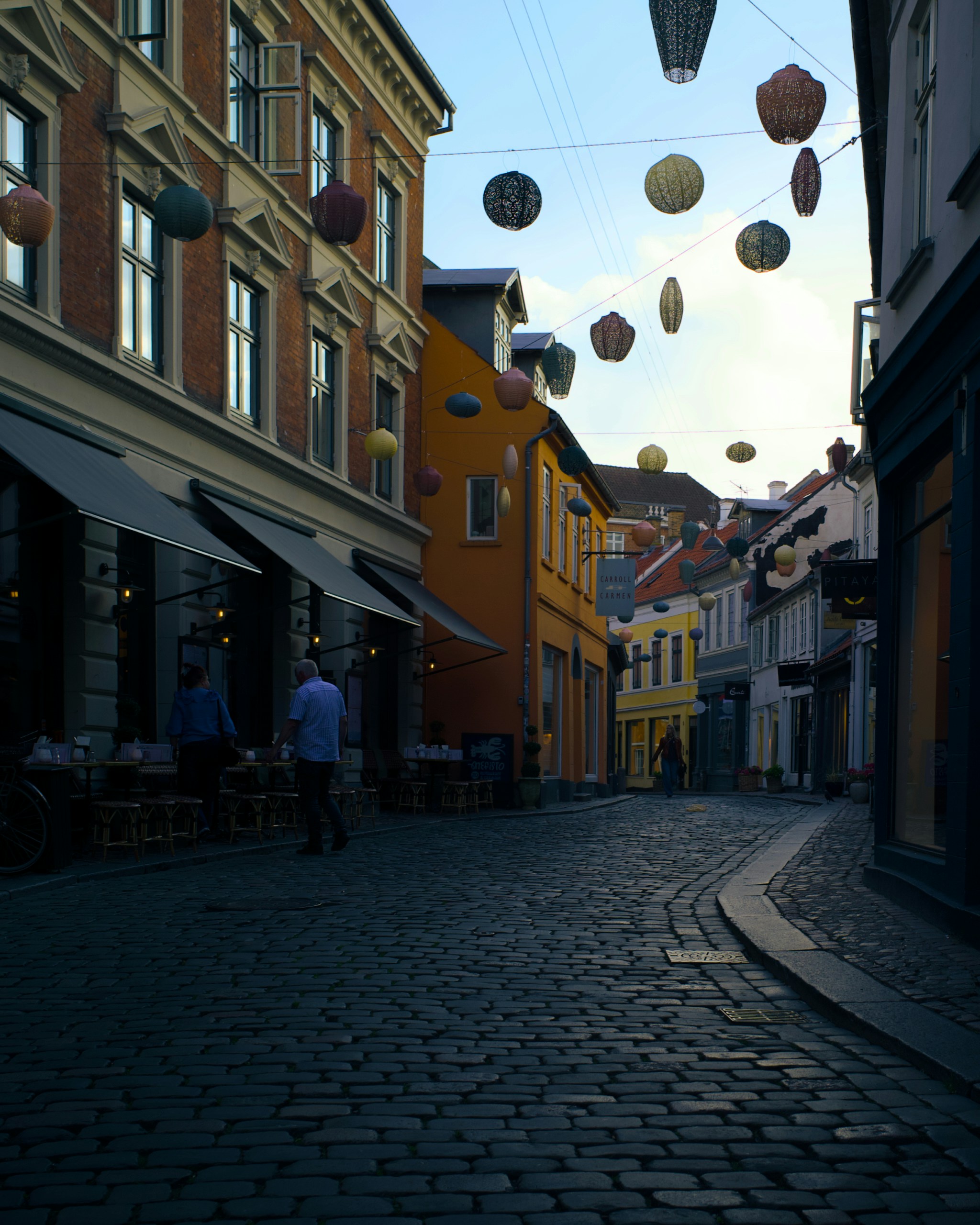 Cobblestone Lane Under Colorful Canopy Lights
