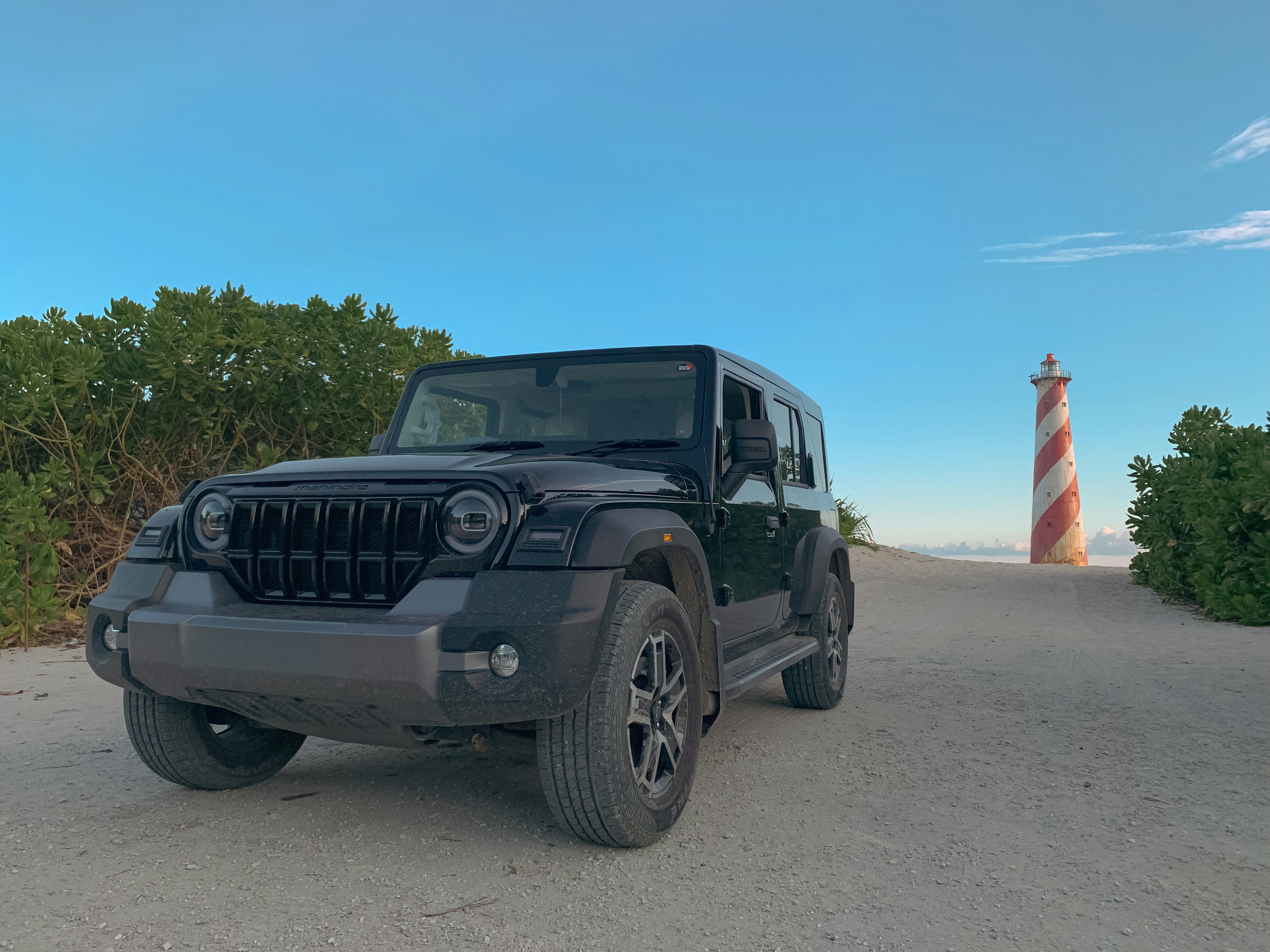 Toward the Edge: A Black Jeep Highlandered by Coastal Light