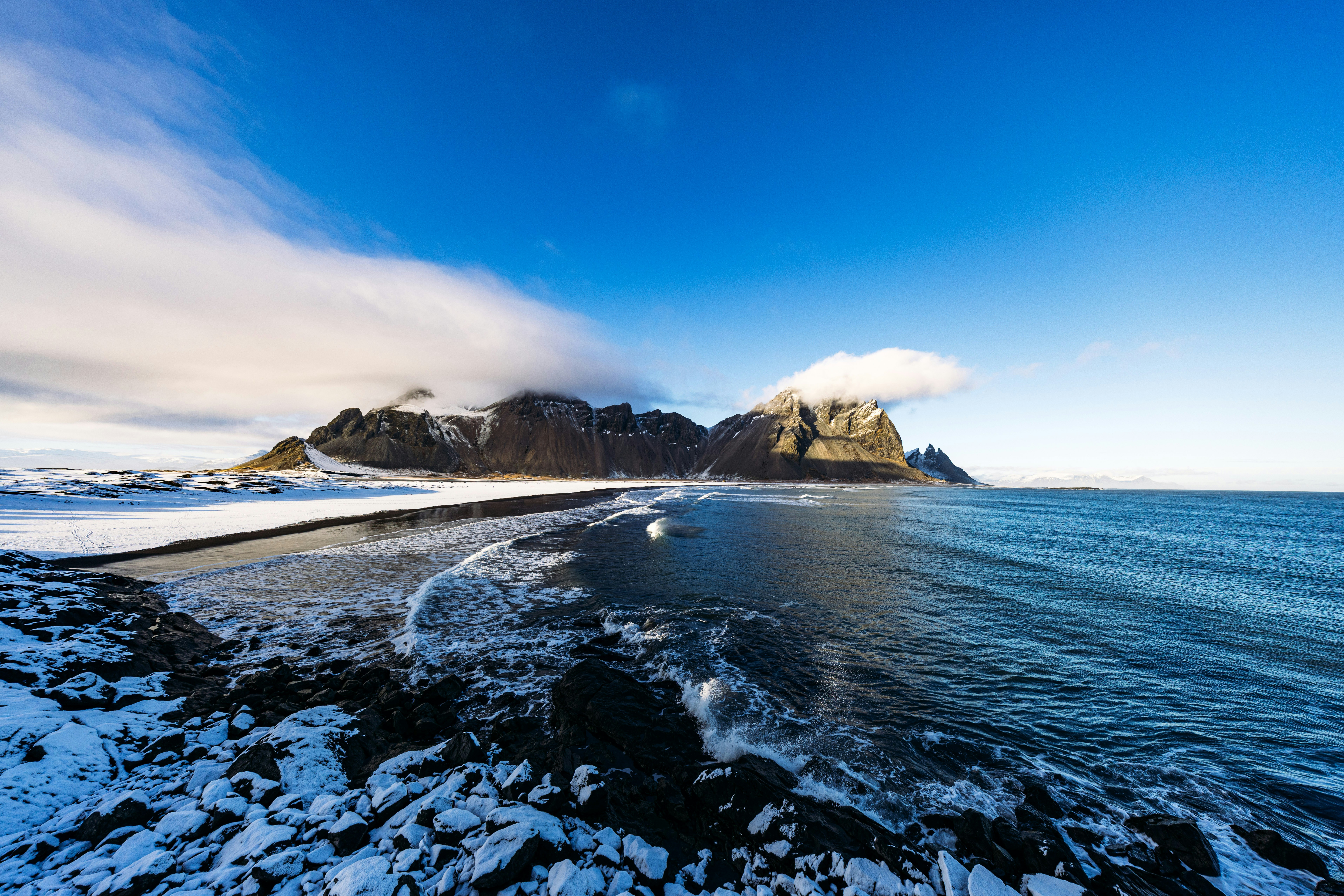 Ice-Crowned Ridge: A Coastal Vista Under Open Sky