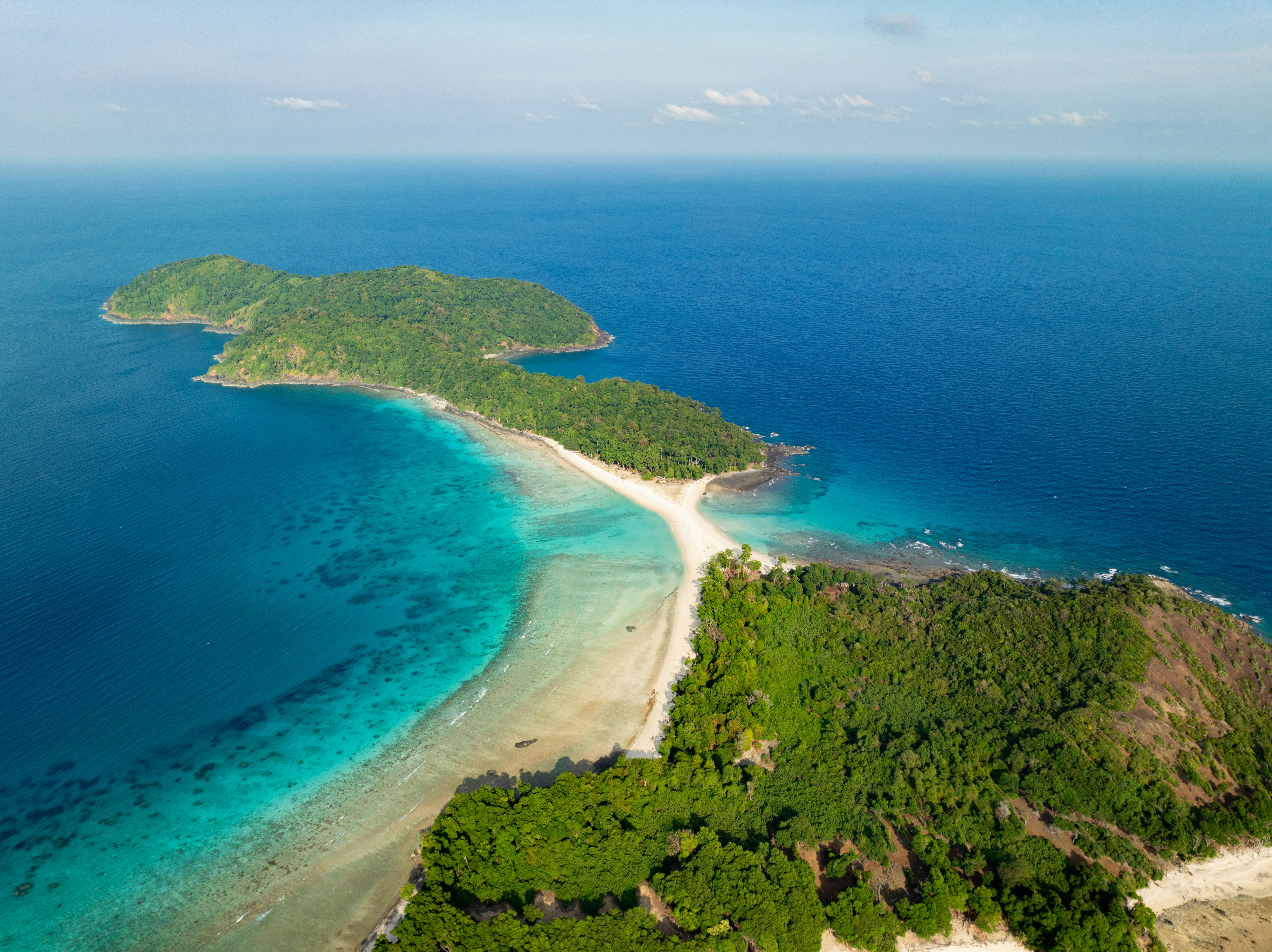 Tropical island with a white sandbar and turquoise ocean.