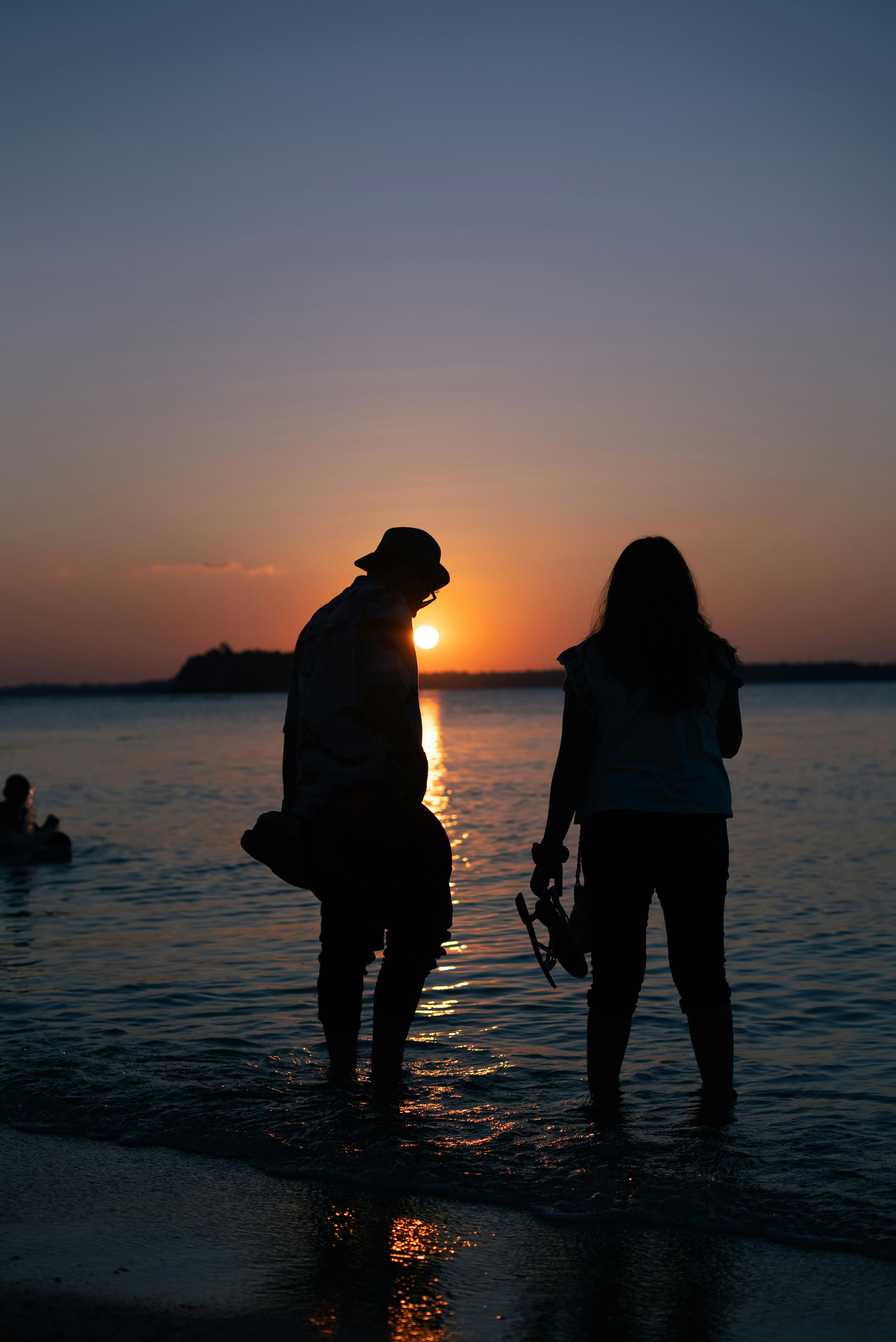 Silhouettes at Sundown: A Quiet Shoreline Moment