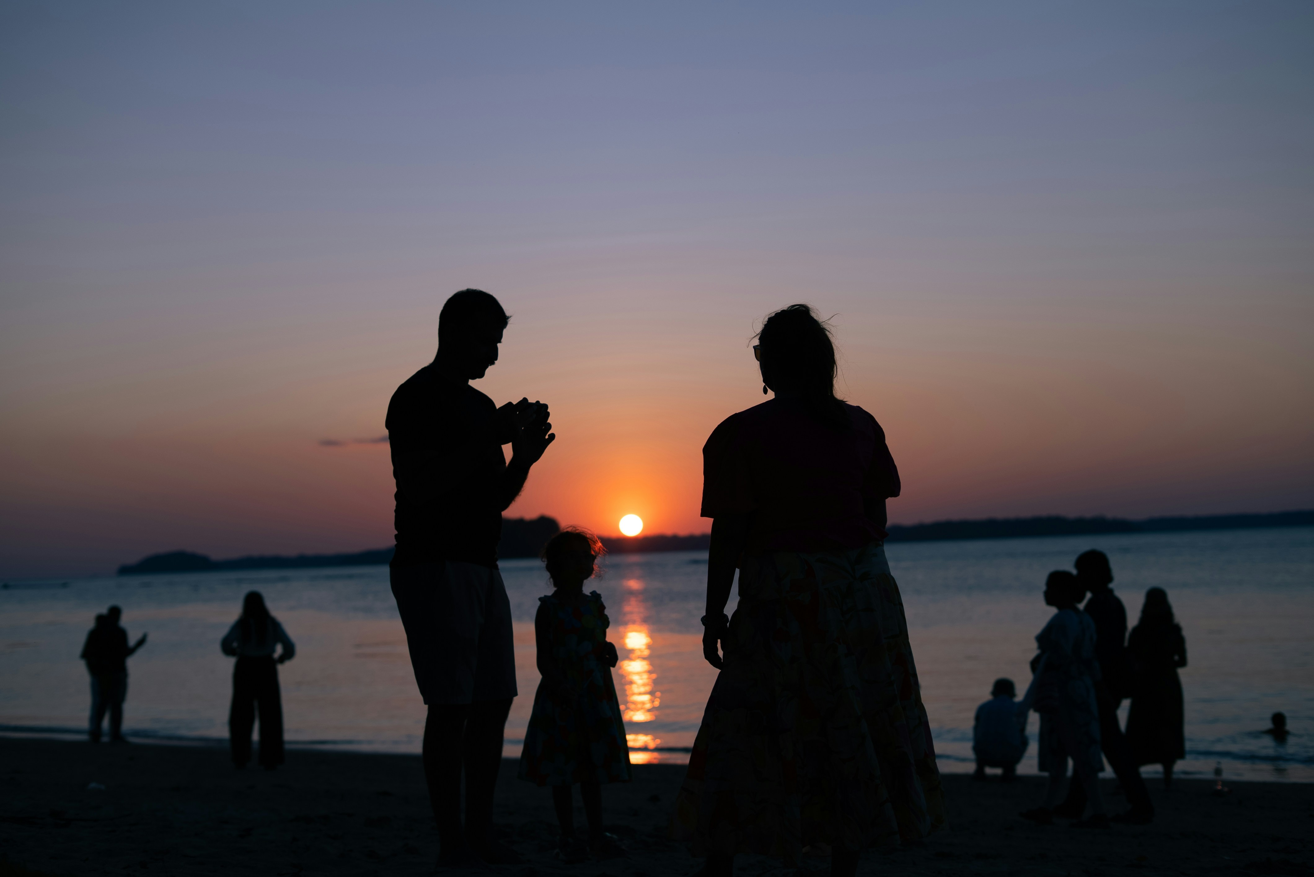 Silhouettes at Sunset: A Quiet Beach Moment