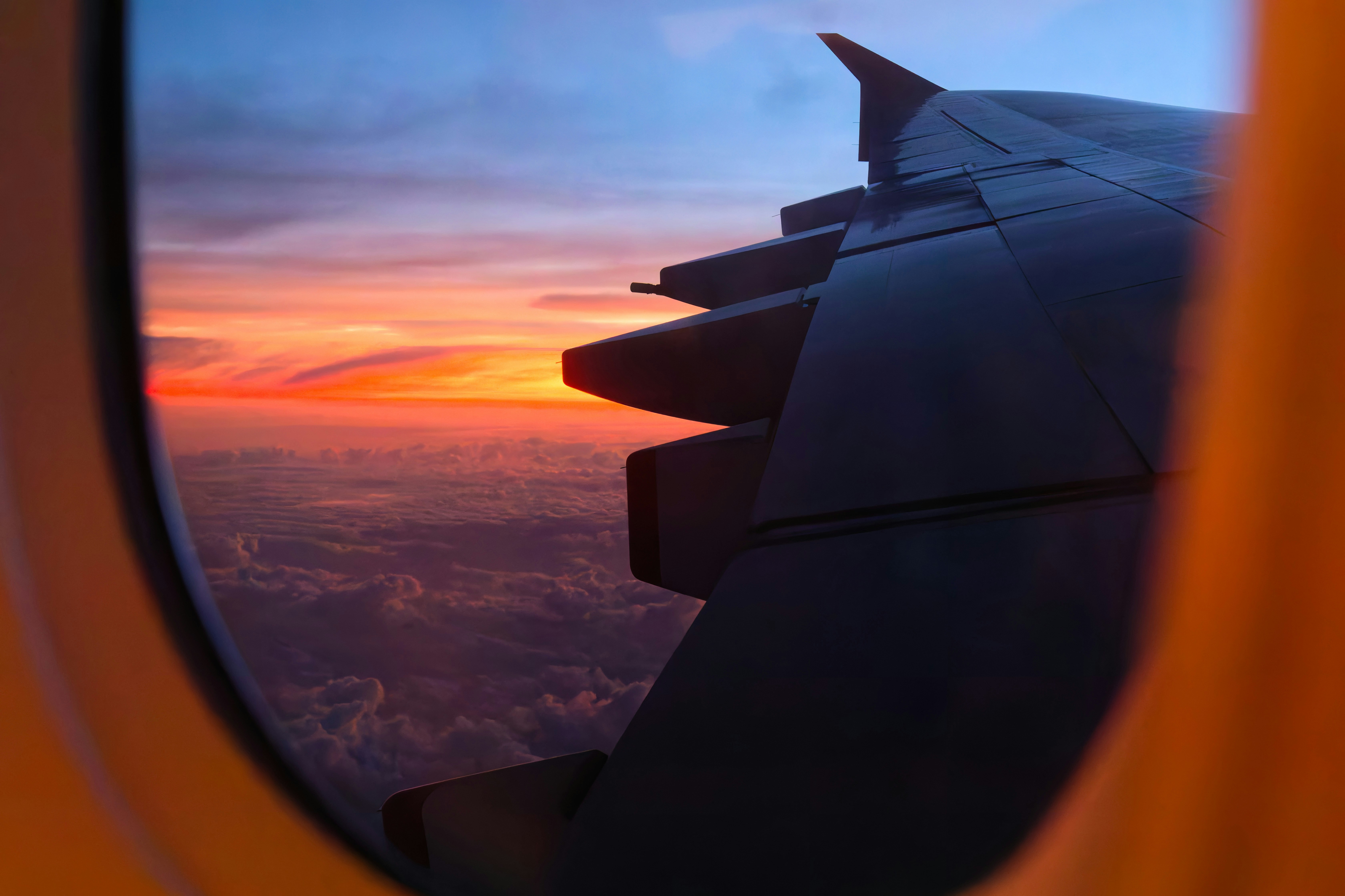 Sunset Lift: Wingtip Silhouettes Beyond the Window