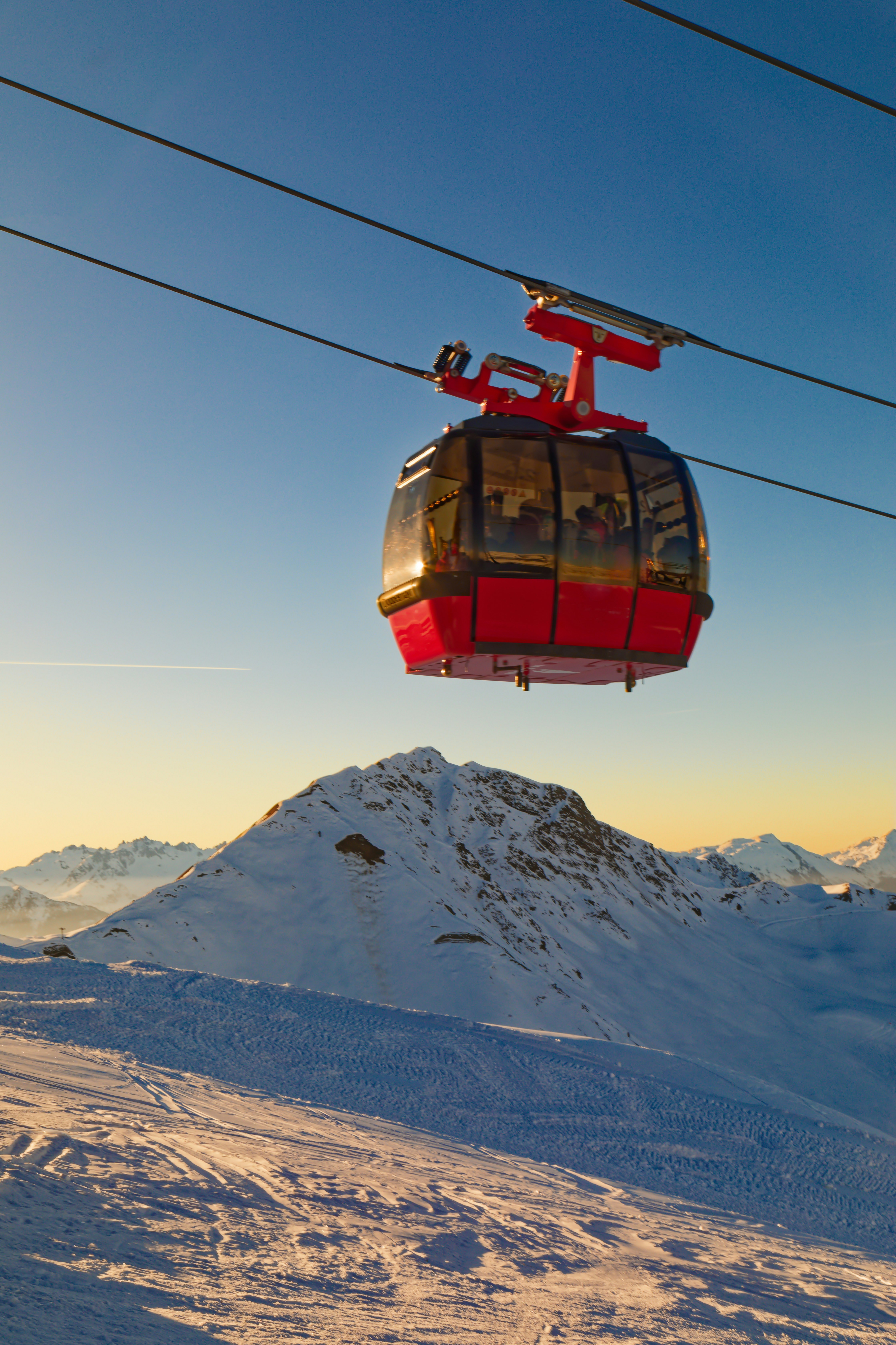 Red Gondola Above the Snowbound Ridge at Sunrise