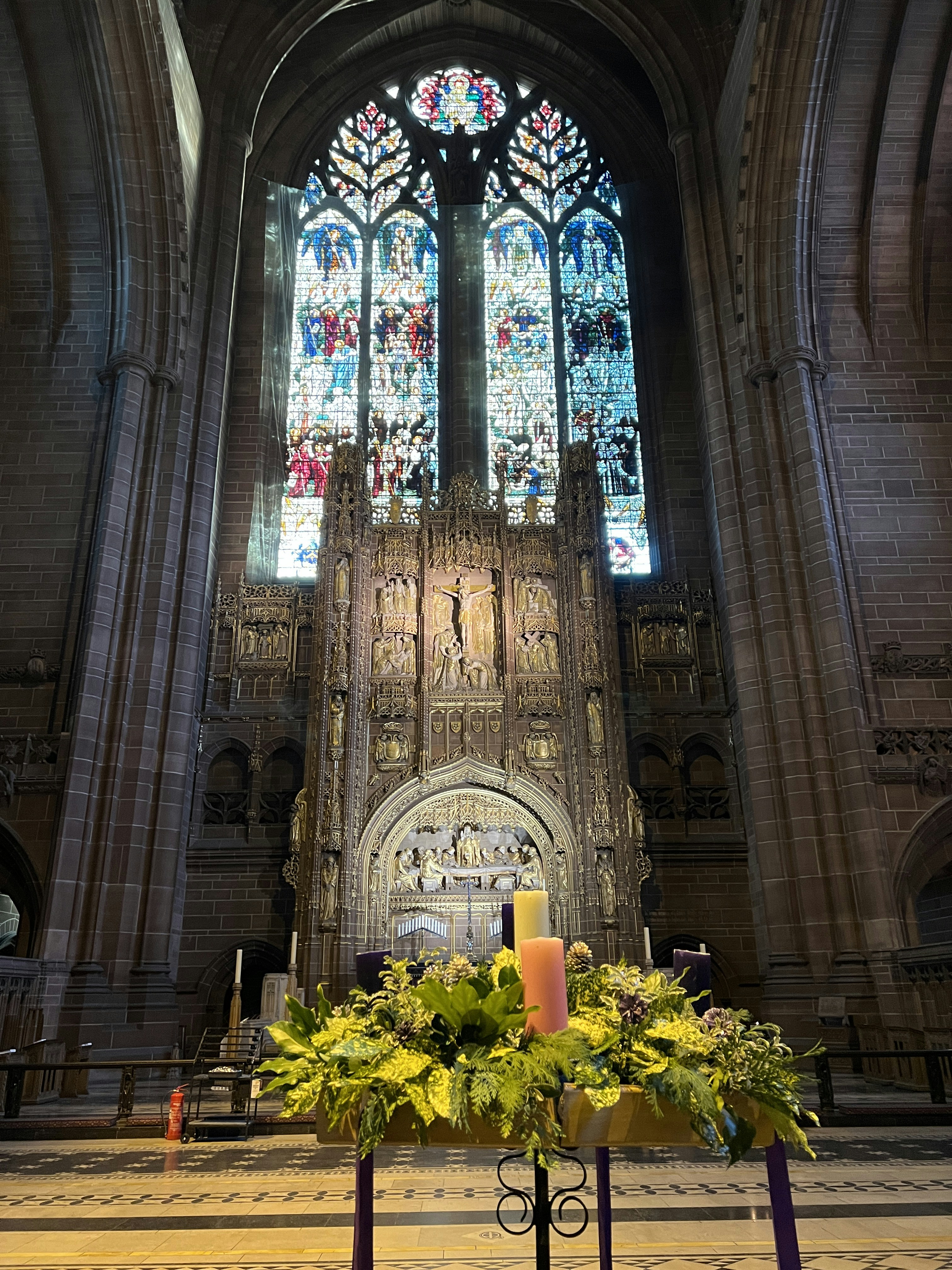 A candlelit altar framed by a grand Gothic church interior
