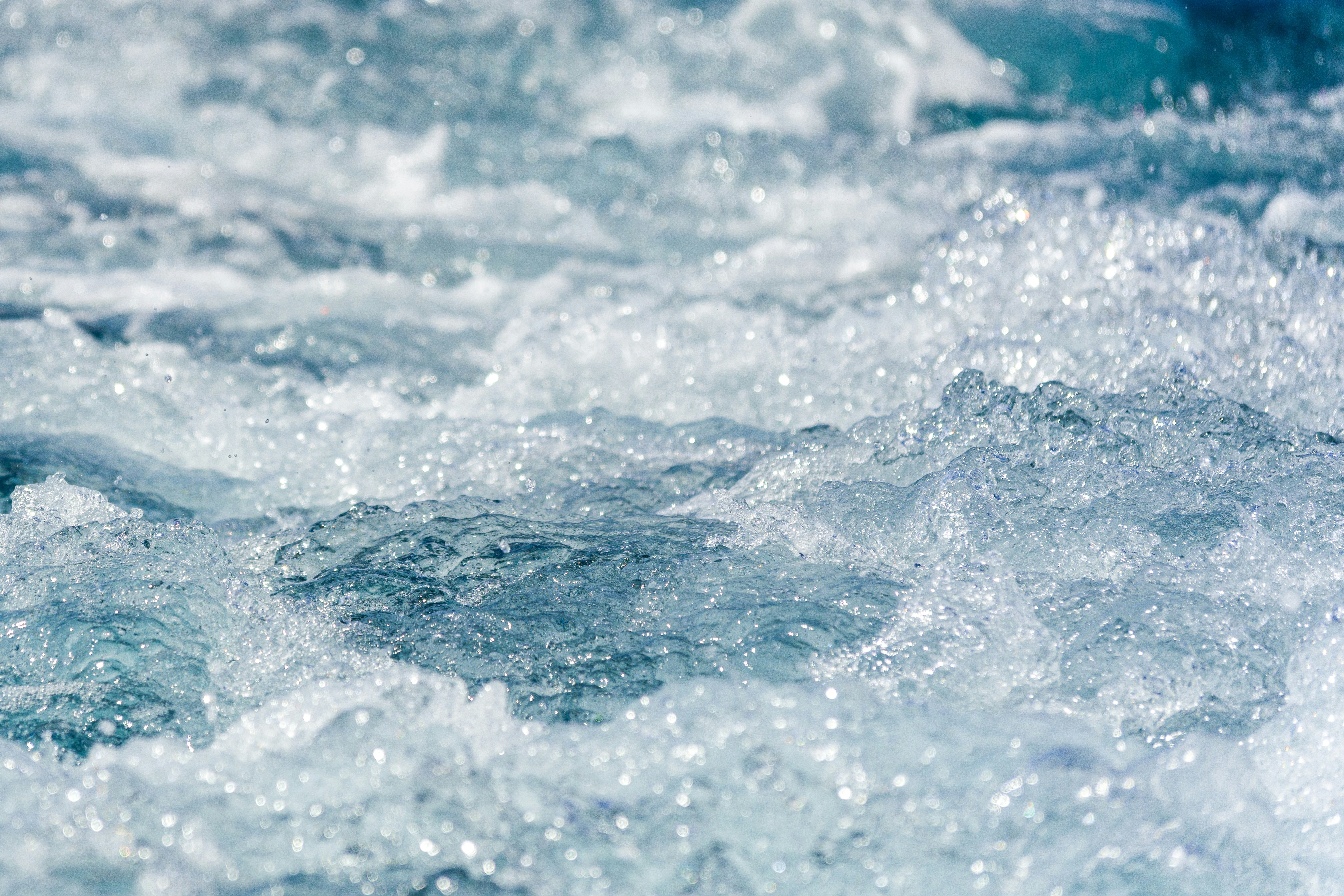 Dynamic blue water with white foamy waves.
