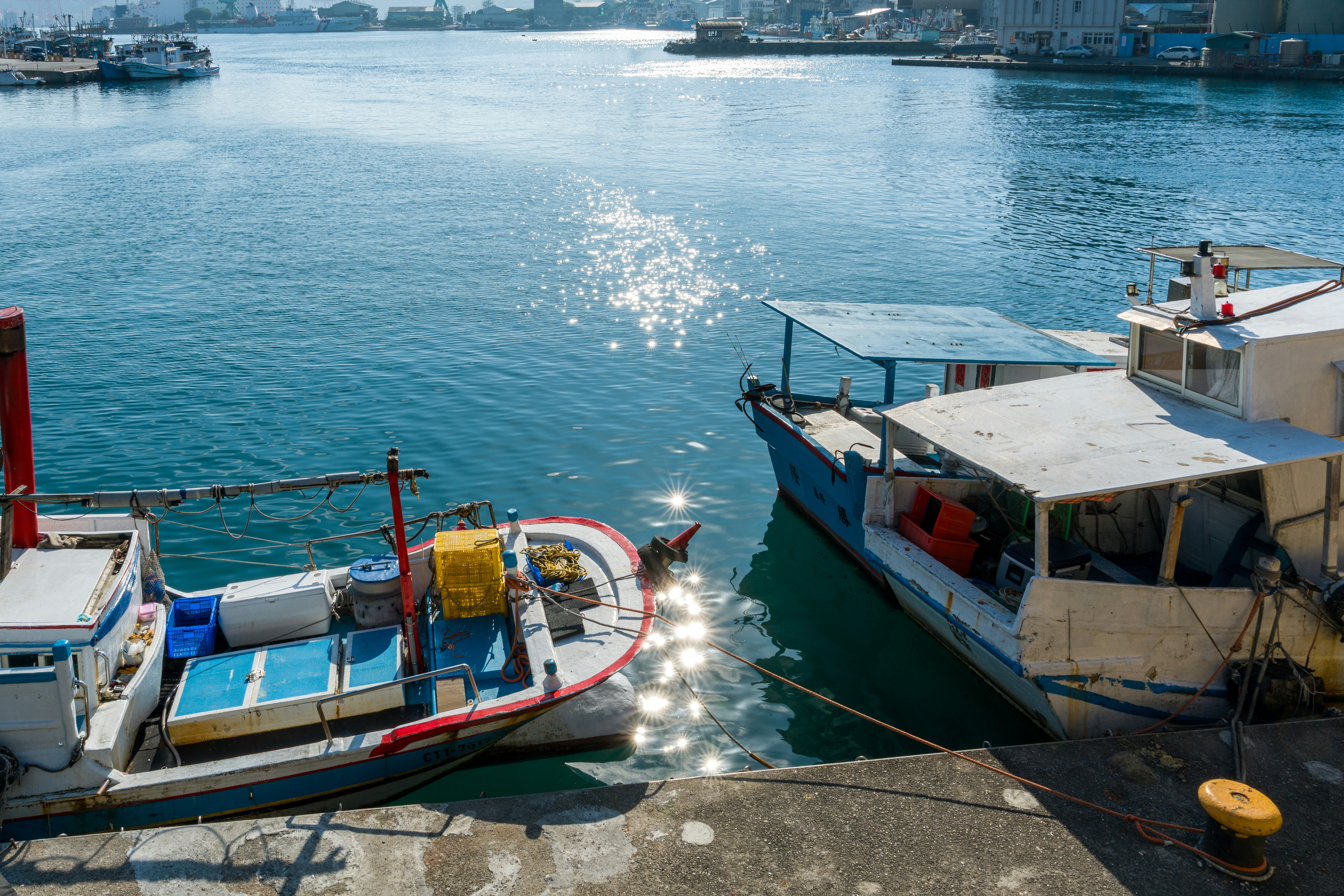 Sunlit Harbor: Boats Moored Along a Quiet Waterfront