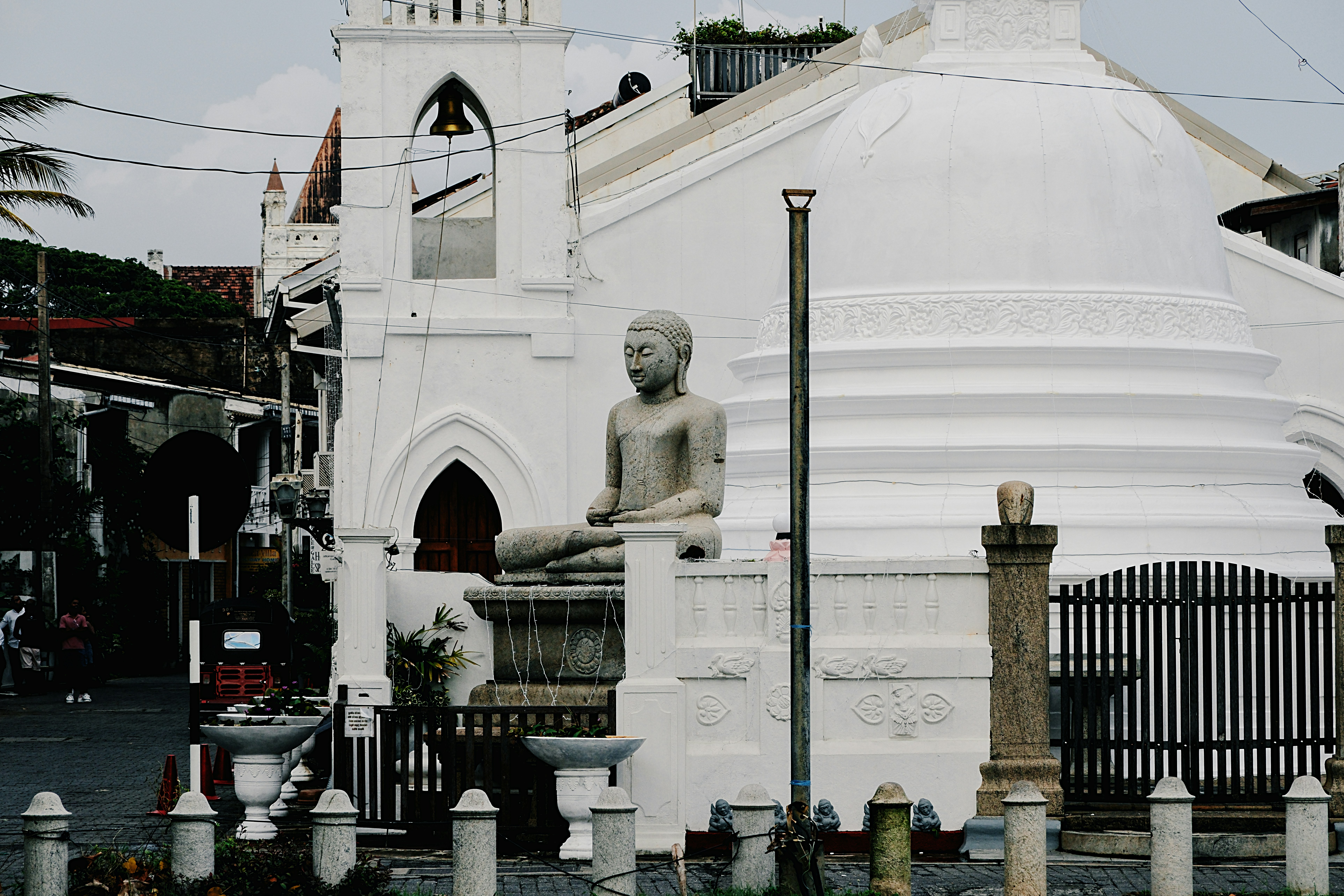 Serene Buddha Nook beside a Monastic White Facade