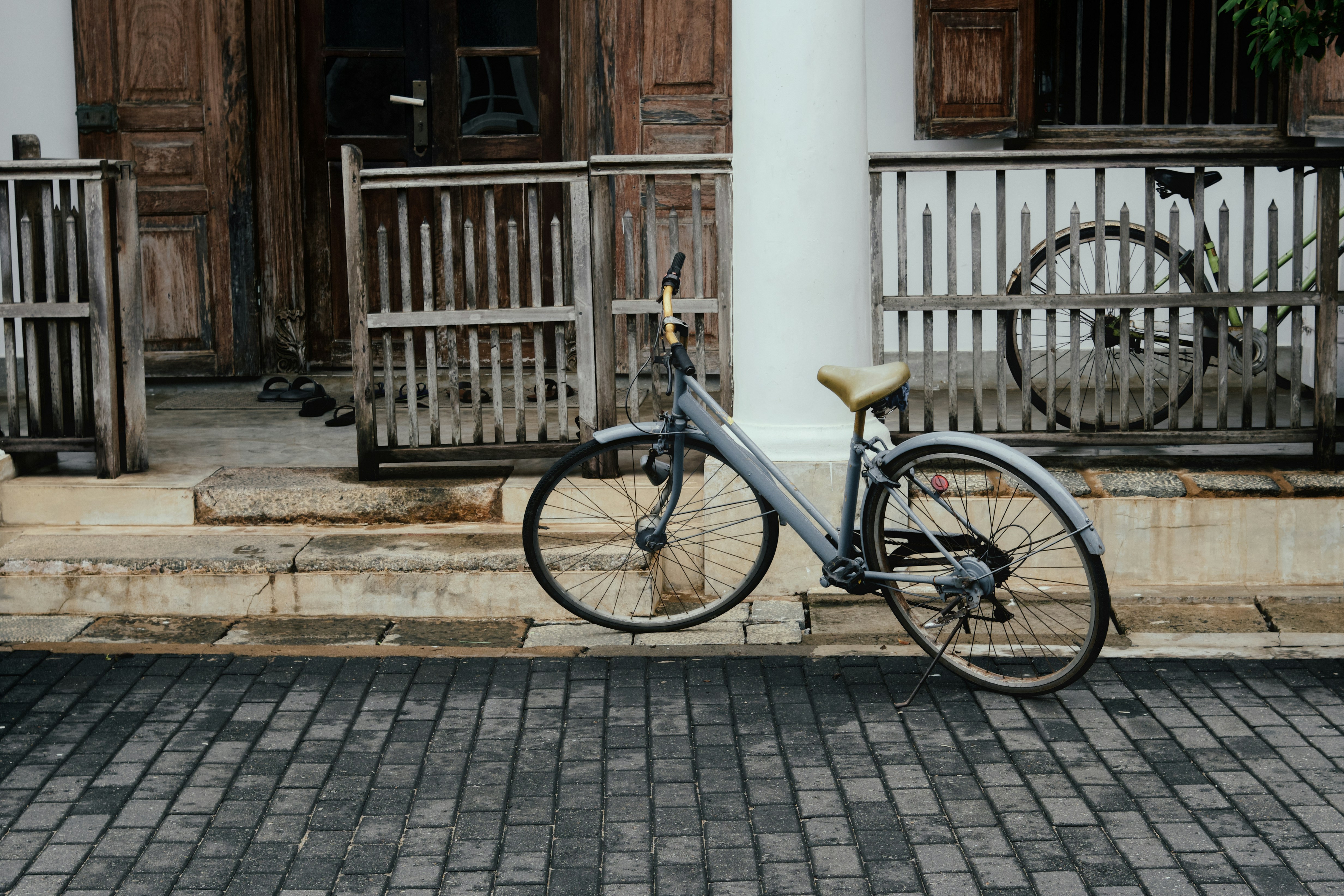 Lonely Grey Bicycle Resting Before Weathered Porch