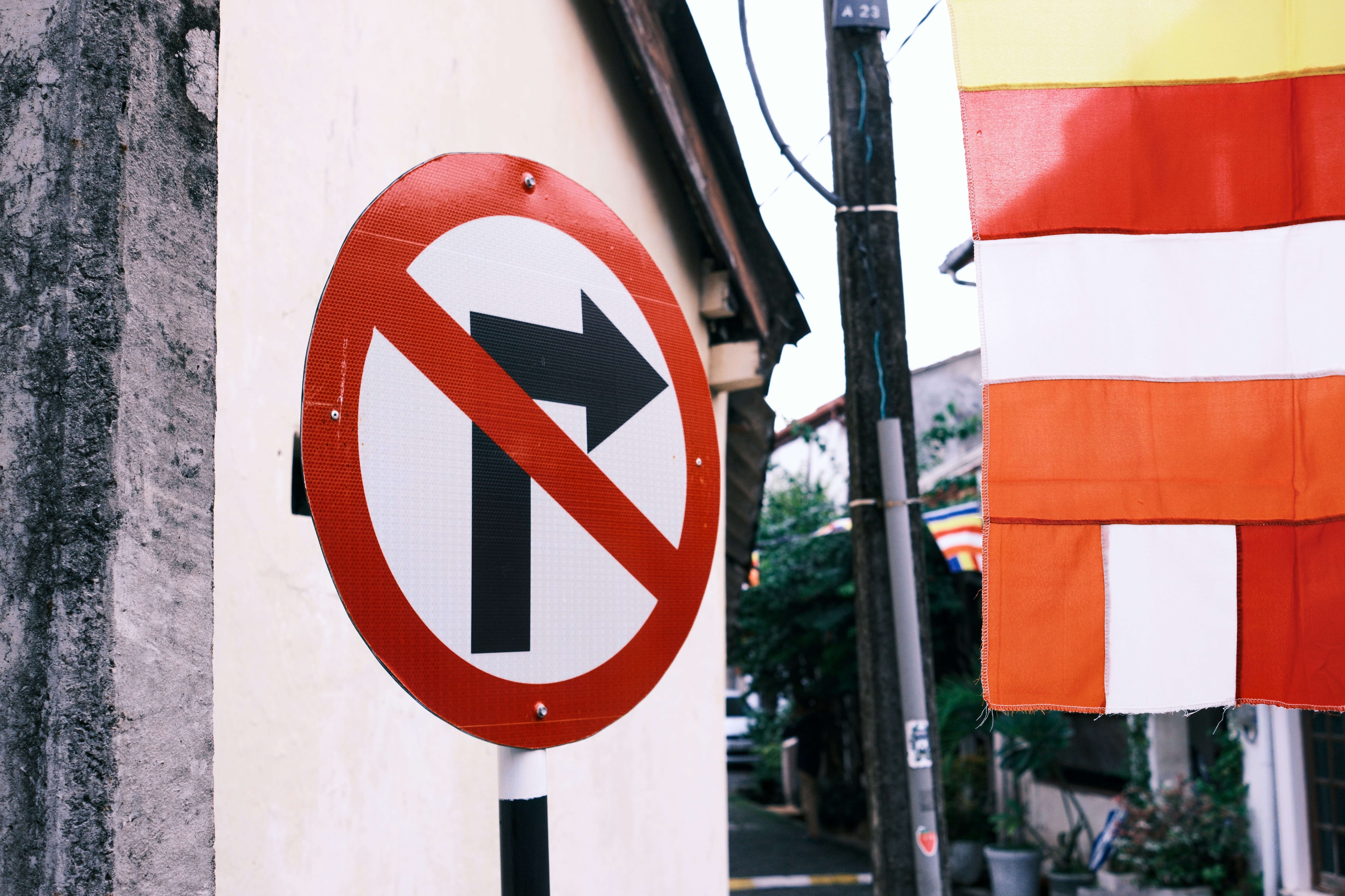 No Turns Allowed: A Red Circle Stares Down a Narrow Street