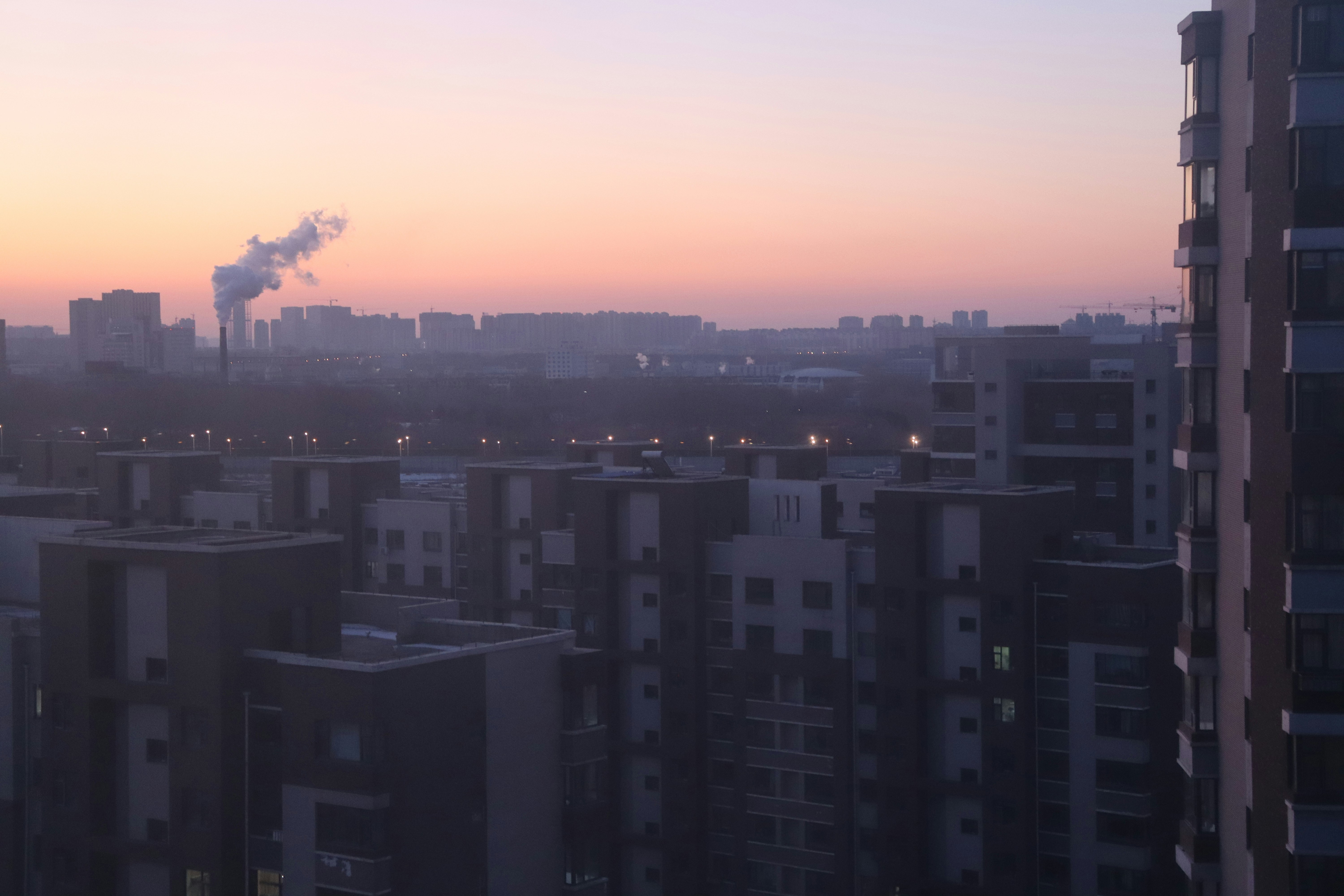 Dawn over the Silent City: Twilight Smoke and Rooftop Silhouettes