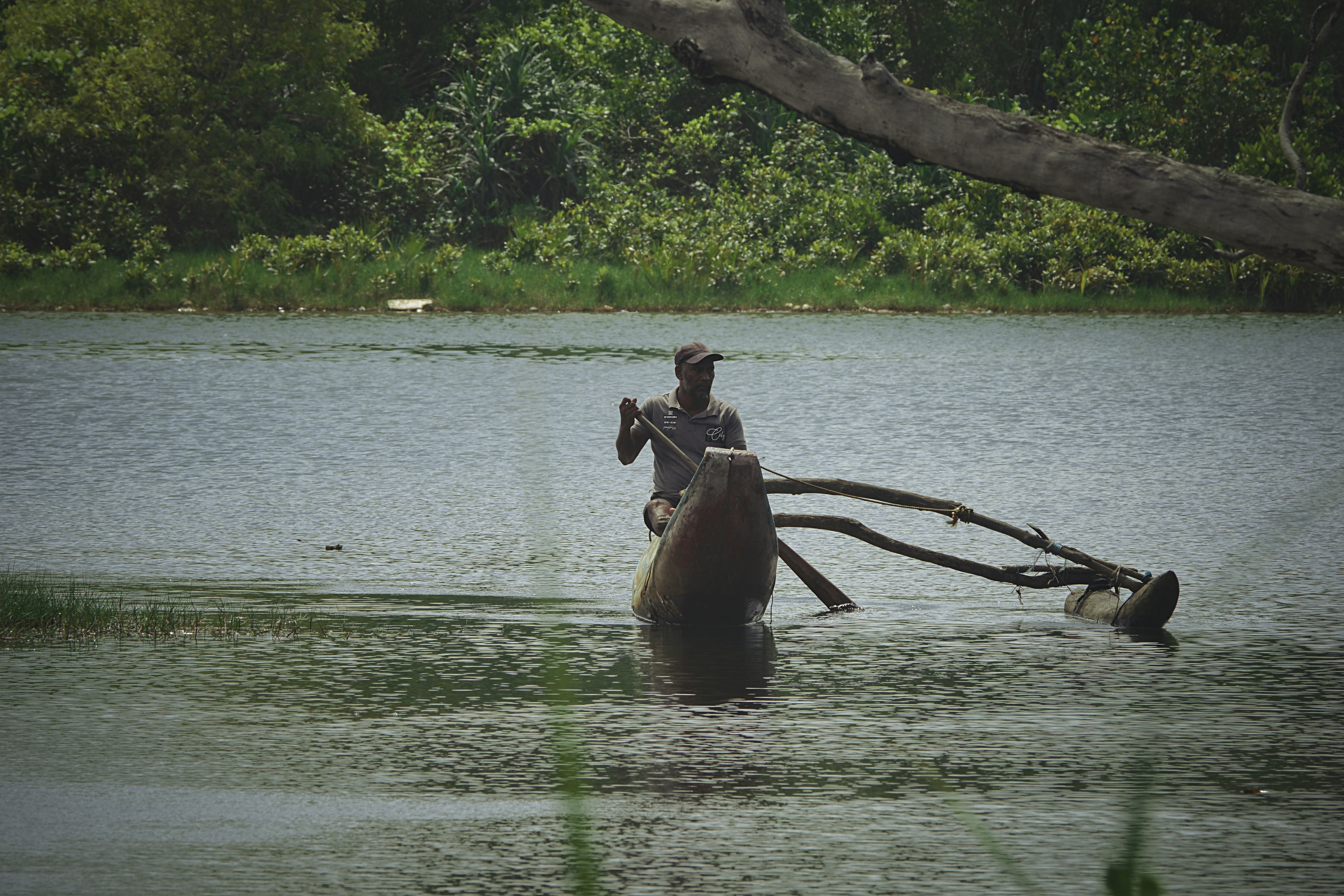 Silhouette at the Bow: A Fisherman in a Quiet River