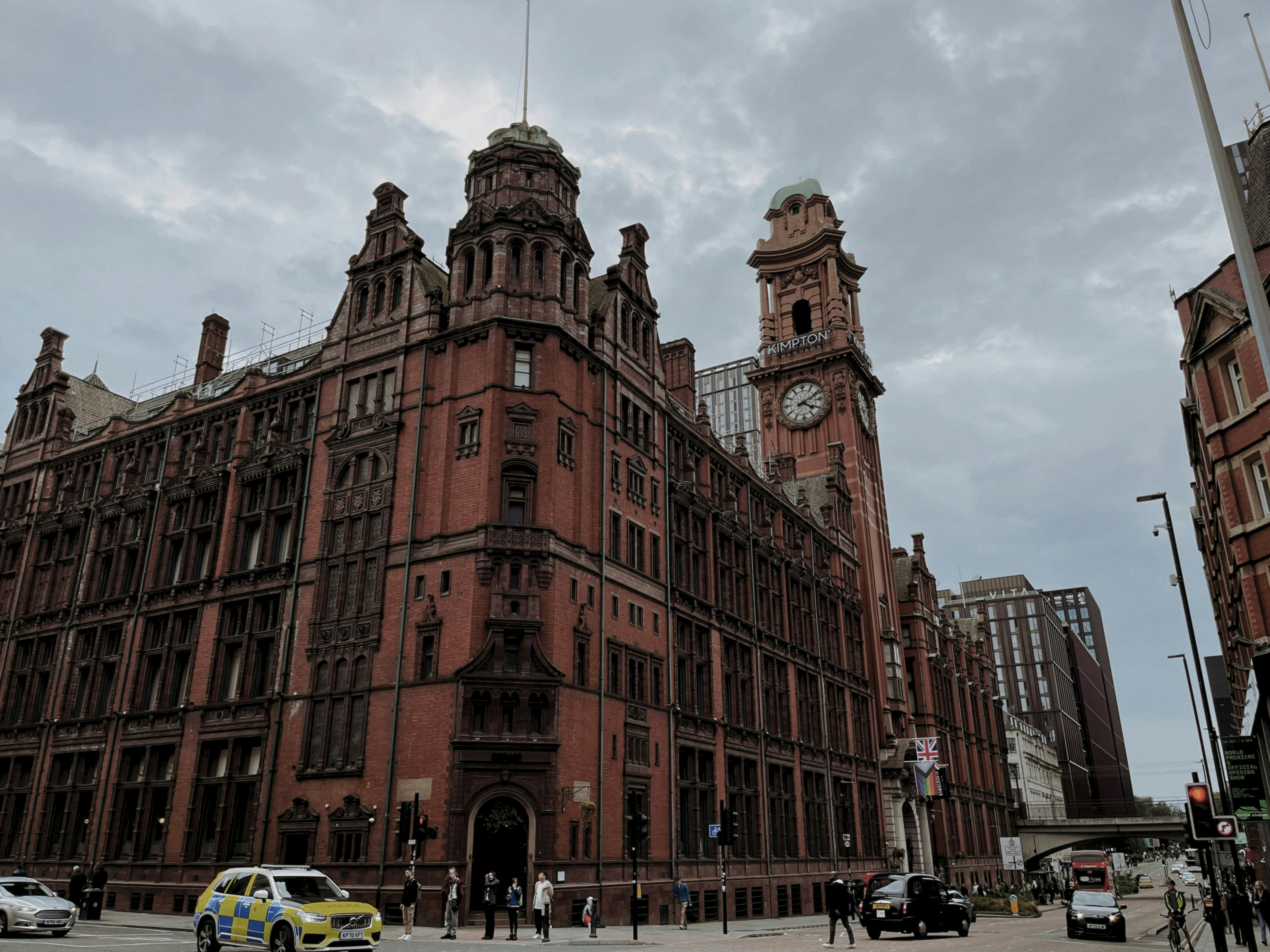Red Brick Clocktower Landmark Under a Clouded Sky