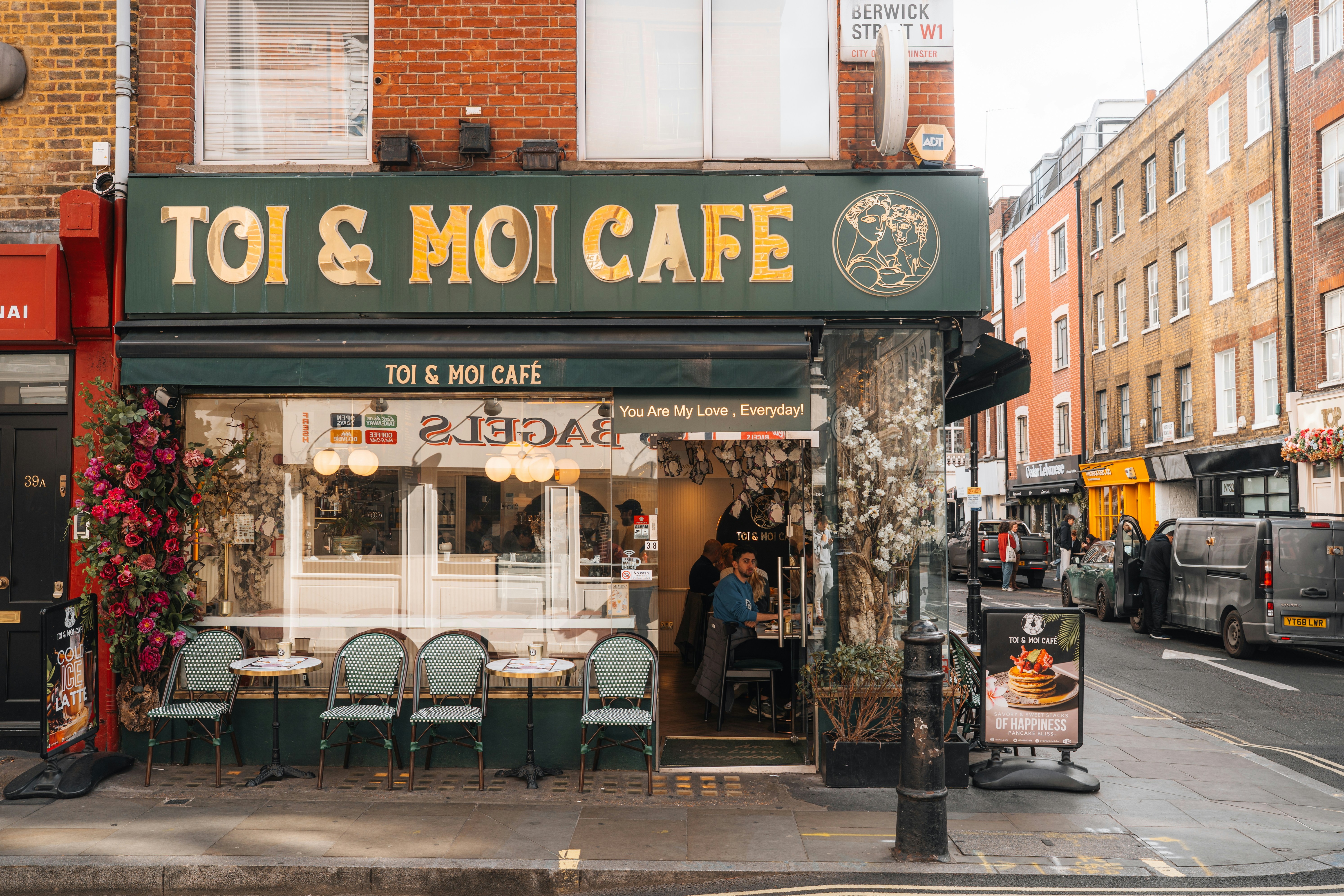 Toi & Moi Café: A London Corner with Warm Light and Greenawn Signage