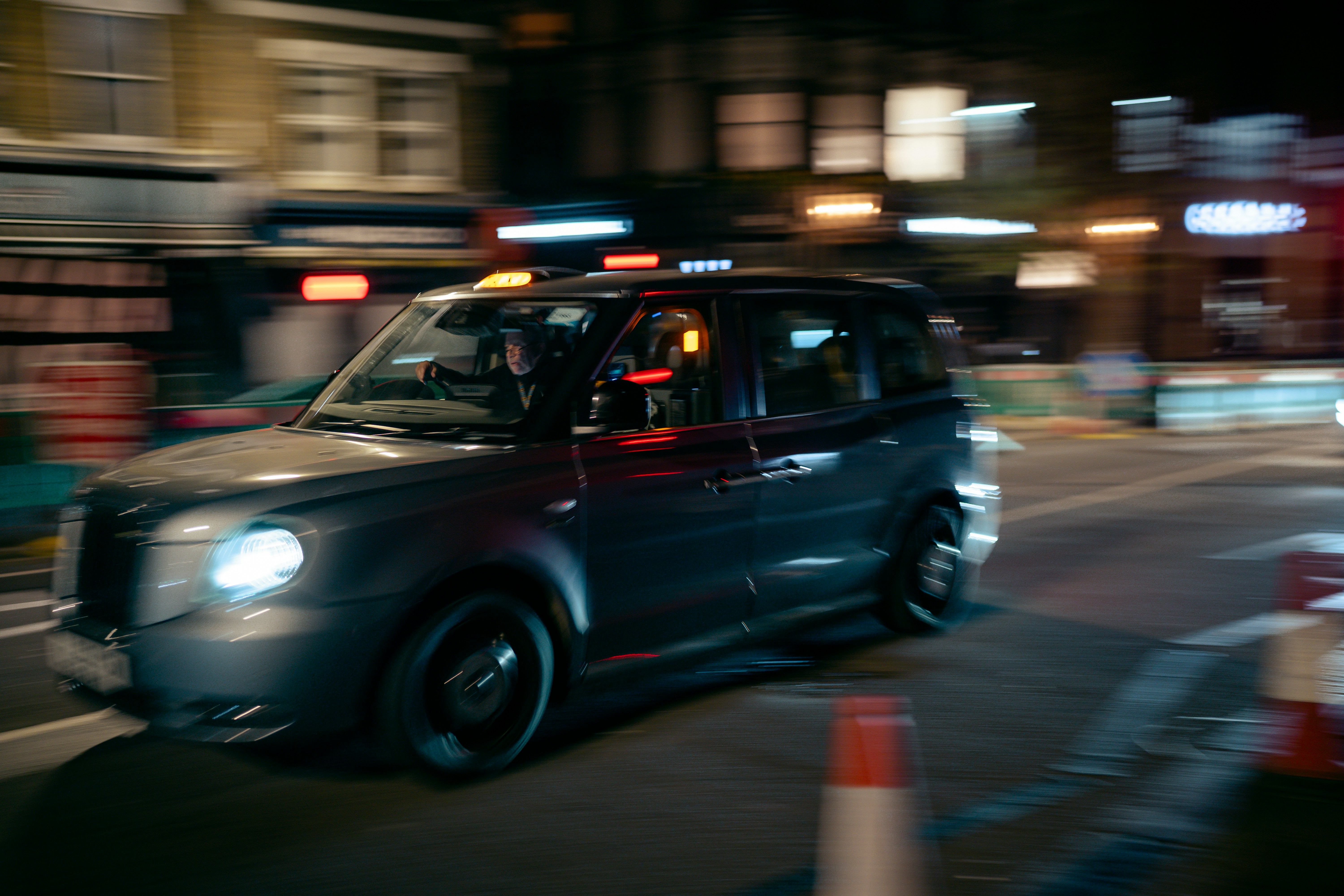 Night City Taxi in Motion: A Blur of Lights and Wheels