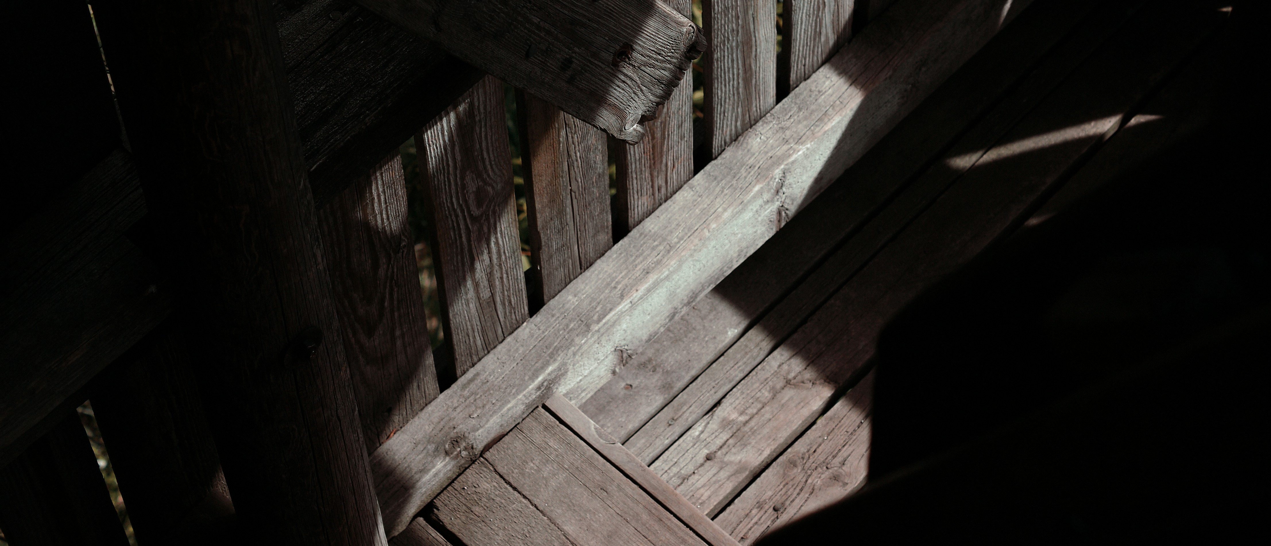 Sunlit Timber Angles: A Patch of Light on Weathered Decking