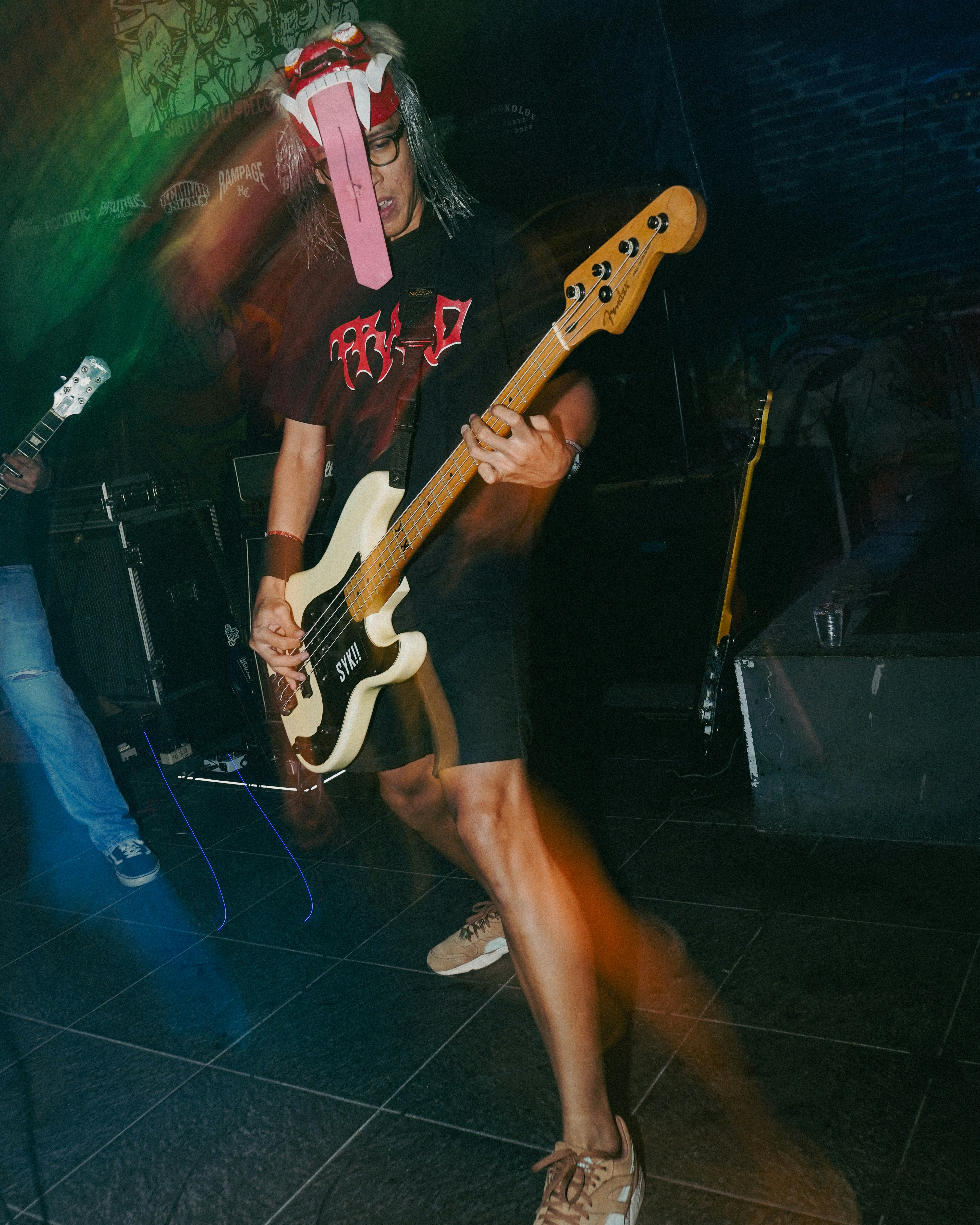 Mid‑stage Groove: A Bassist in Motion Under Neon Club Lights