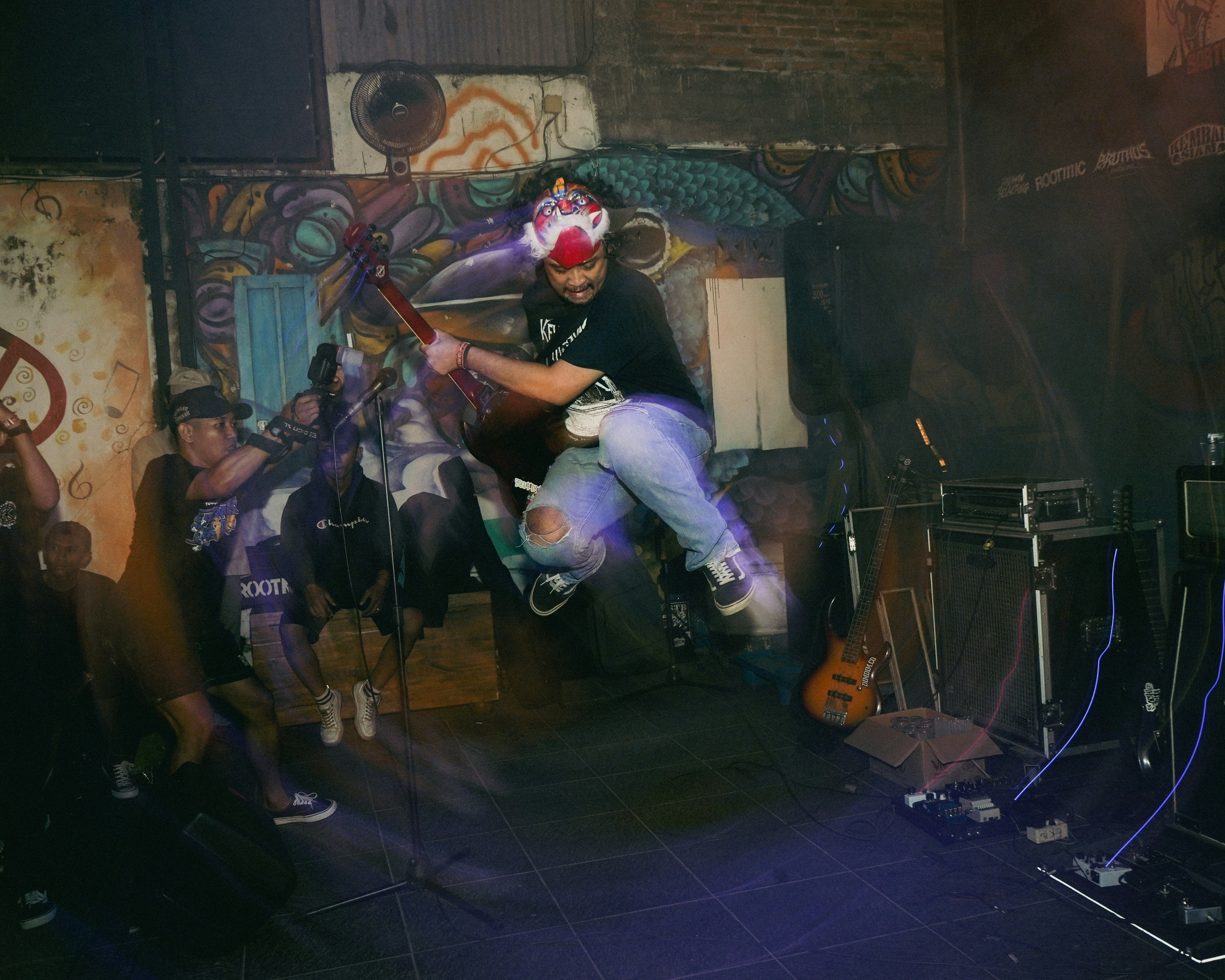 High-Flying Masked Performer Over a Chaotic Stage