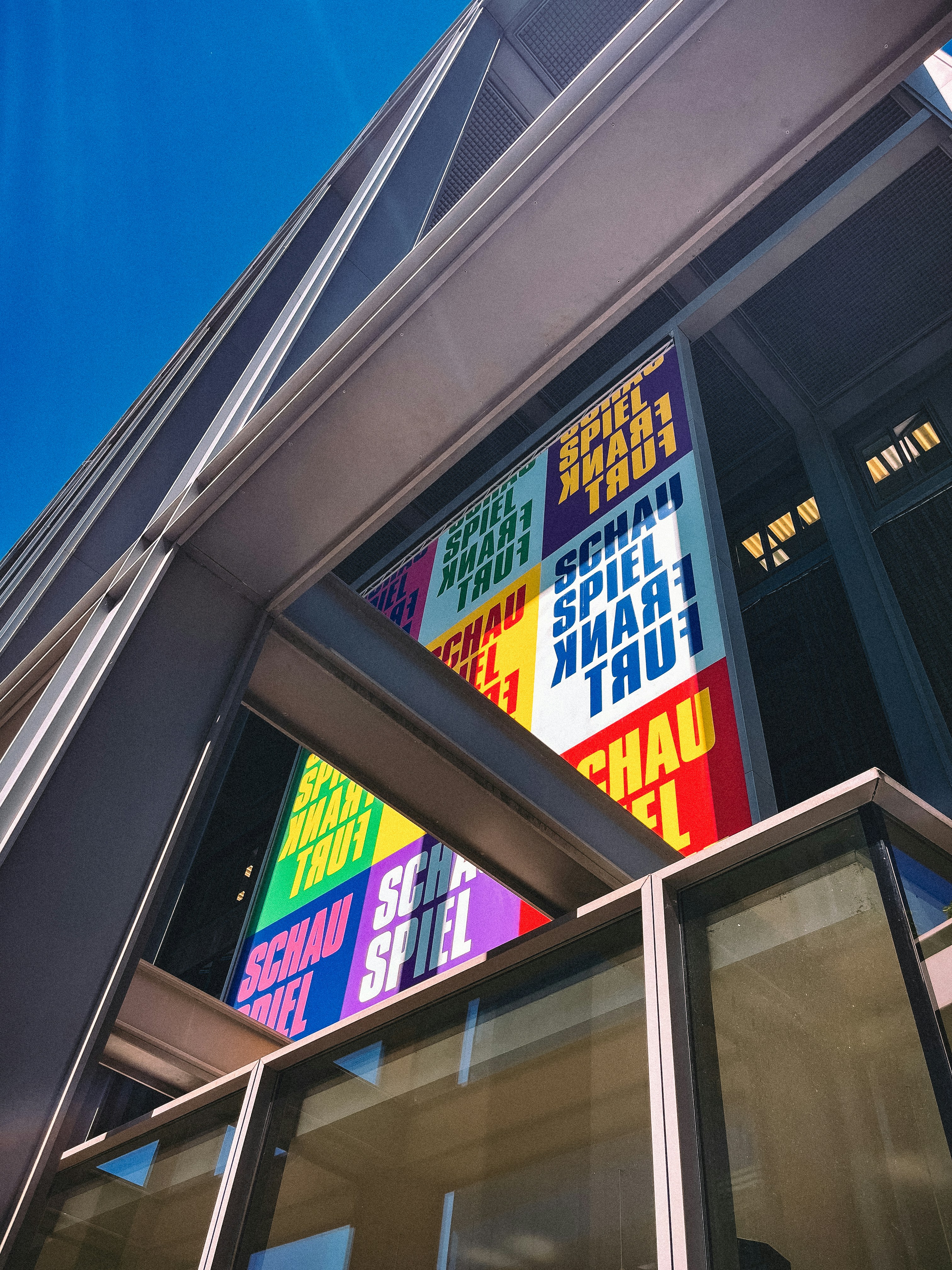 Vibrant "schauspiel frankfurt" sign on a contemporary building.