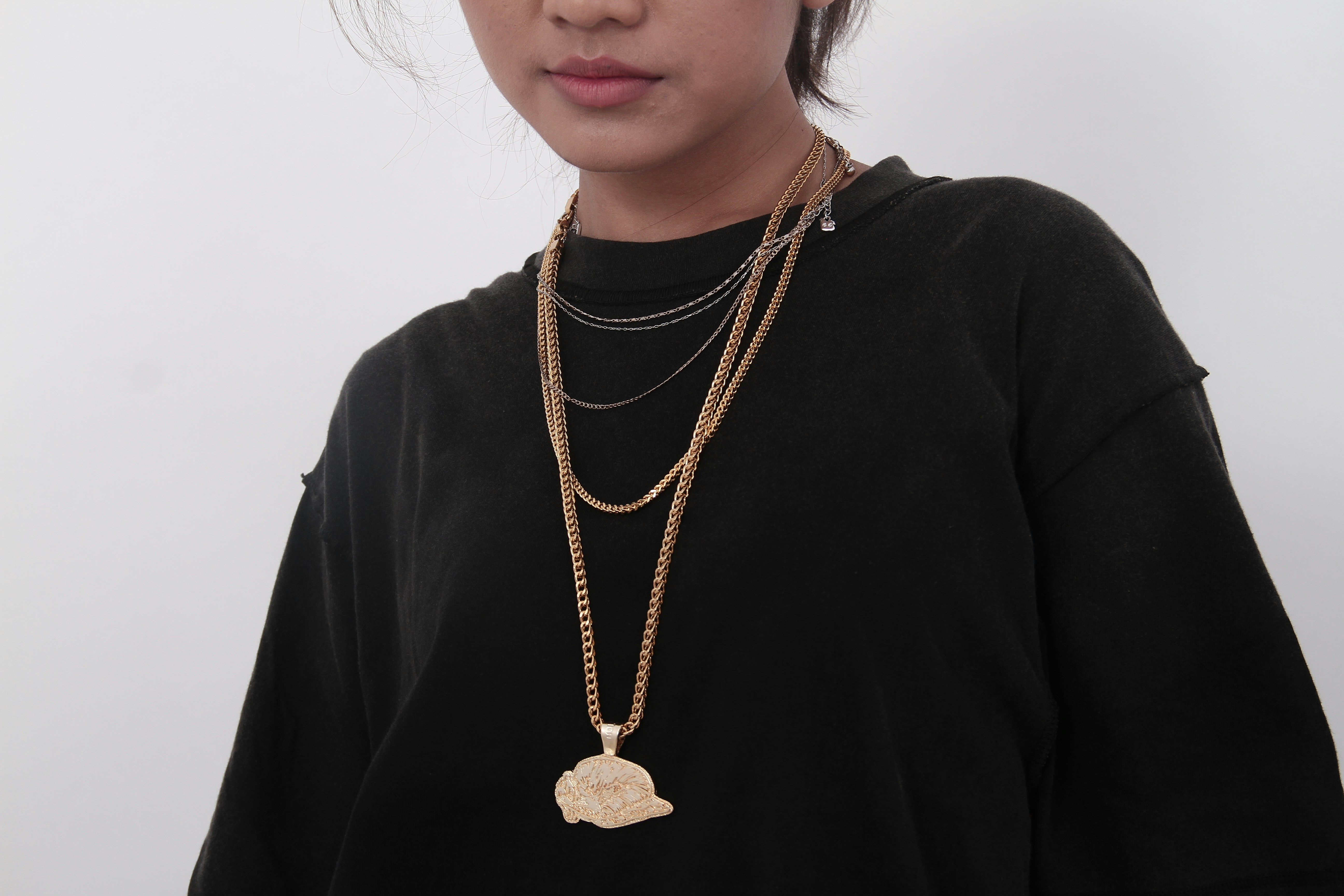 Layered gold: chains resting on a dark tee