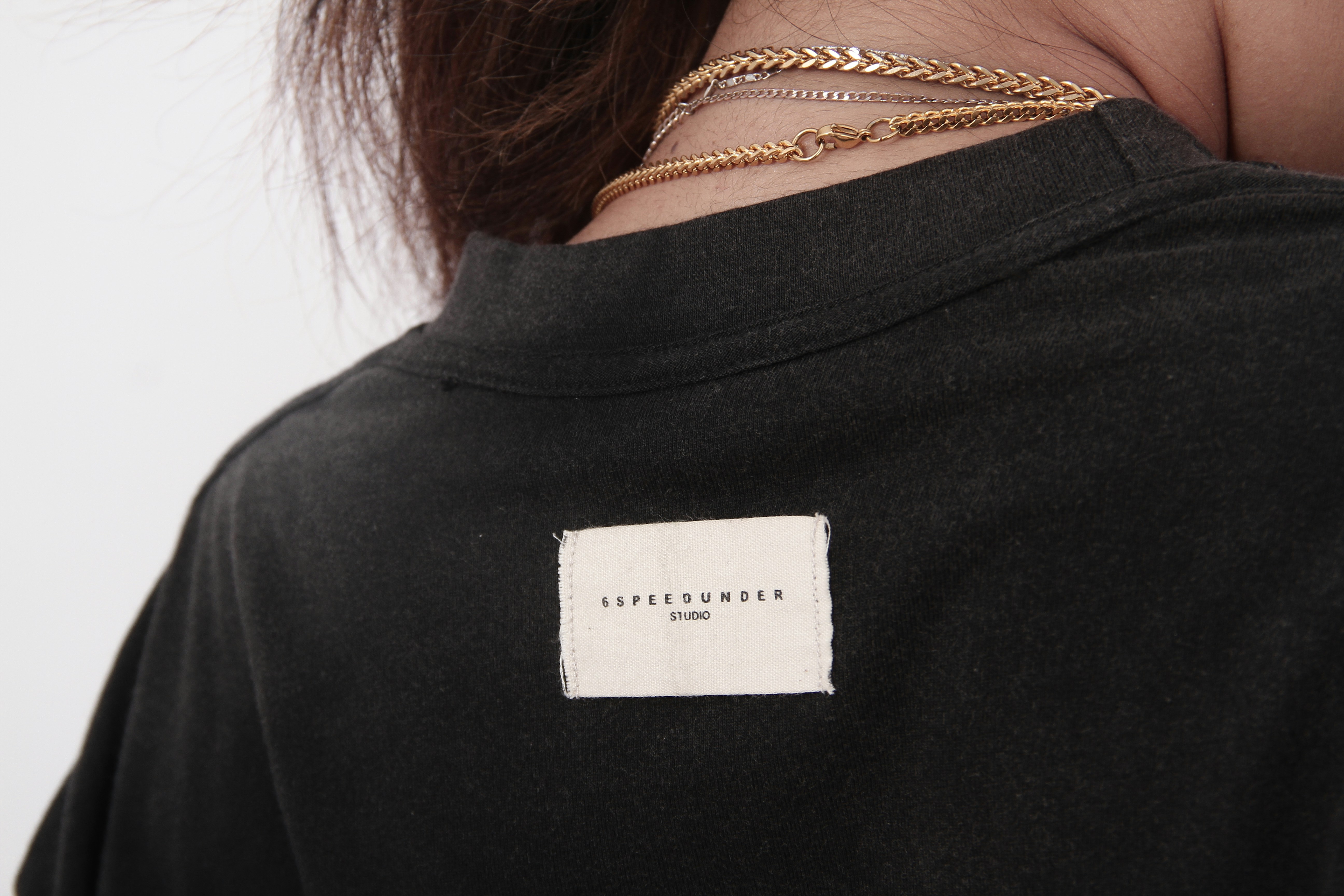 Label on the Back: Subtle Branding with a Close Neckline Detail