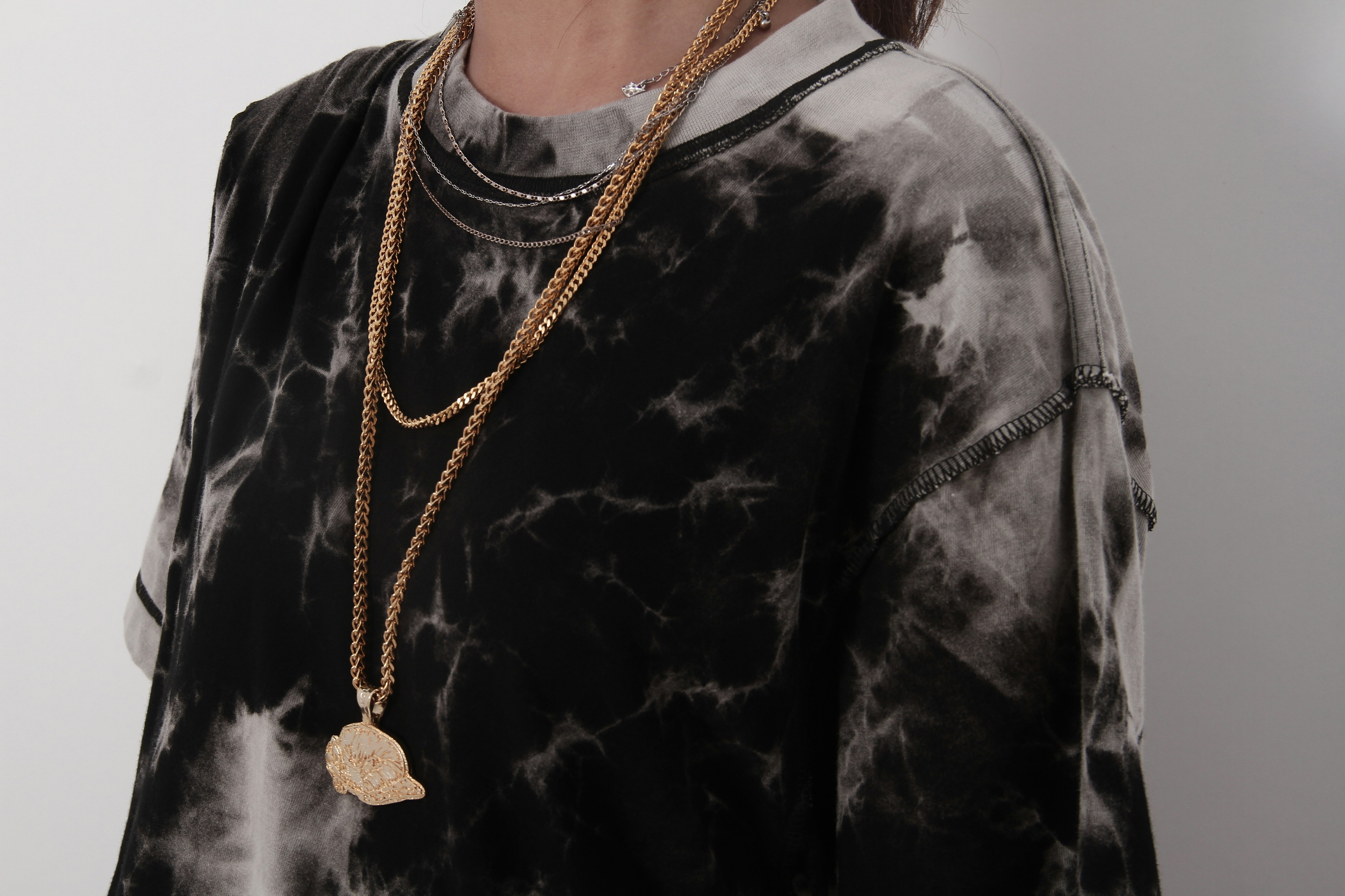 Layered Chains and Monochrome Mood on a Tie-Dyed T-Shirt