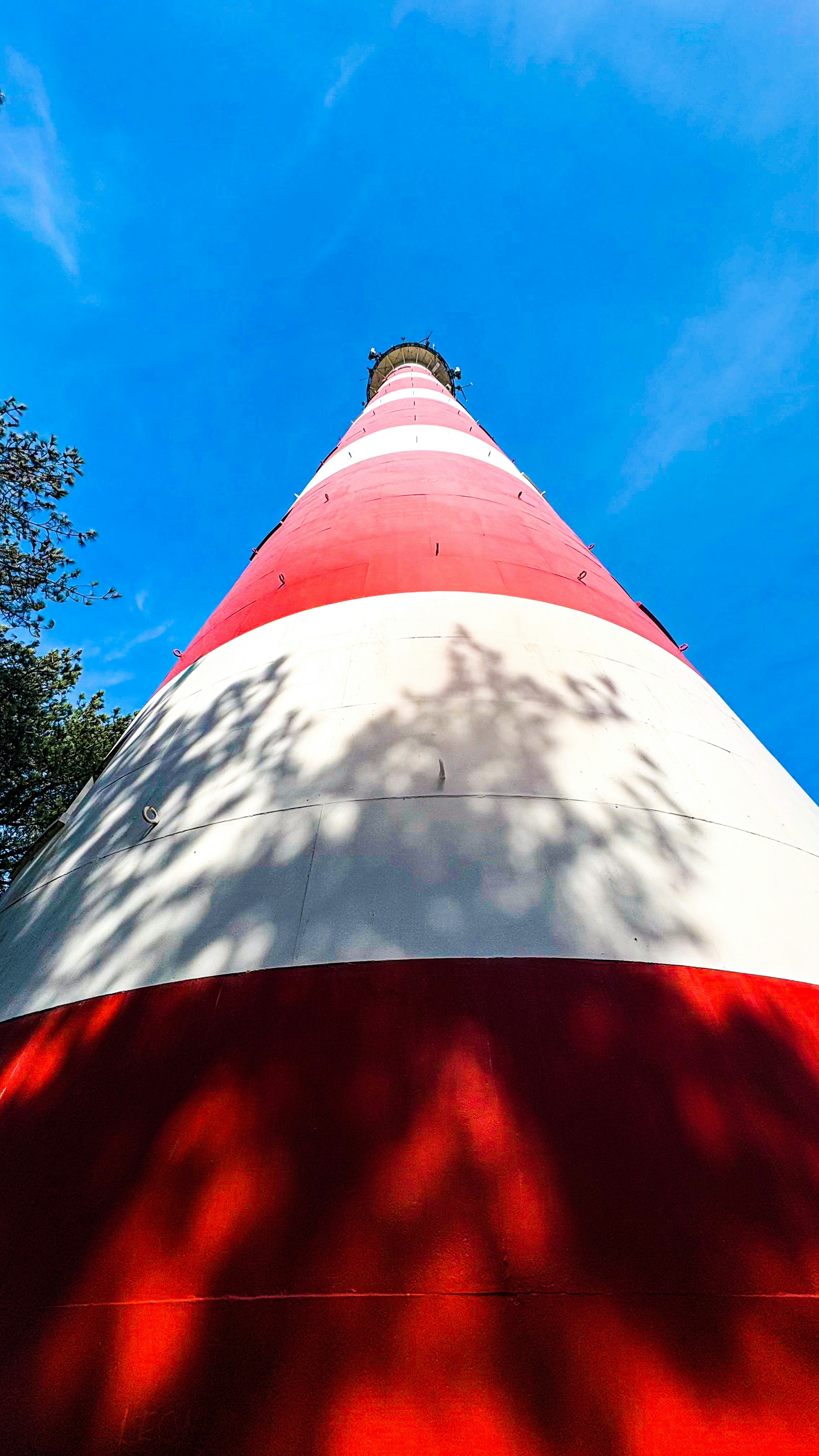 Towering stripes: a upward gaze at a red-and-white beacon