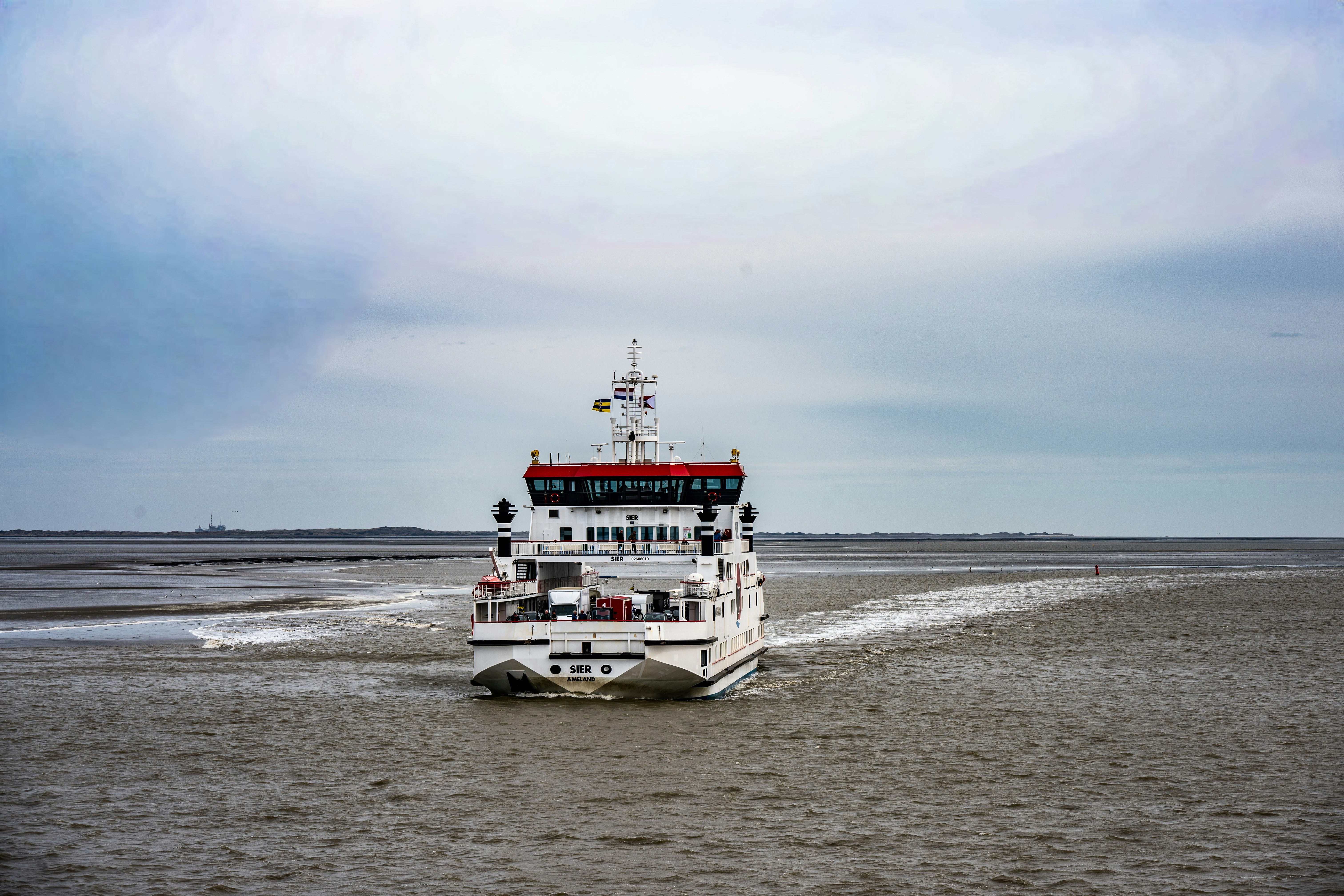 Toward the Tidal Mouth: A lone passenger ferry anchors the mudflats