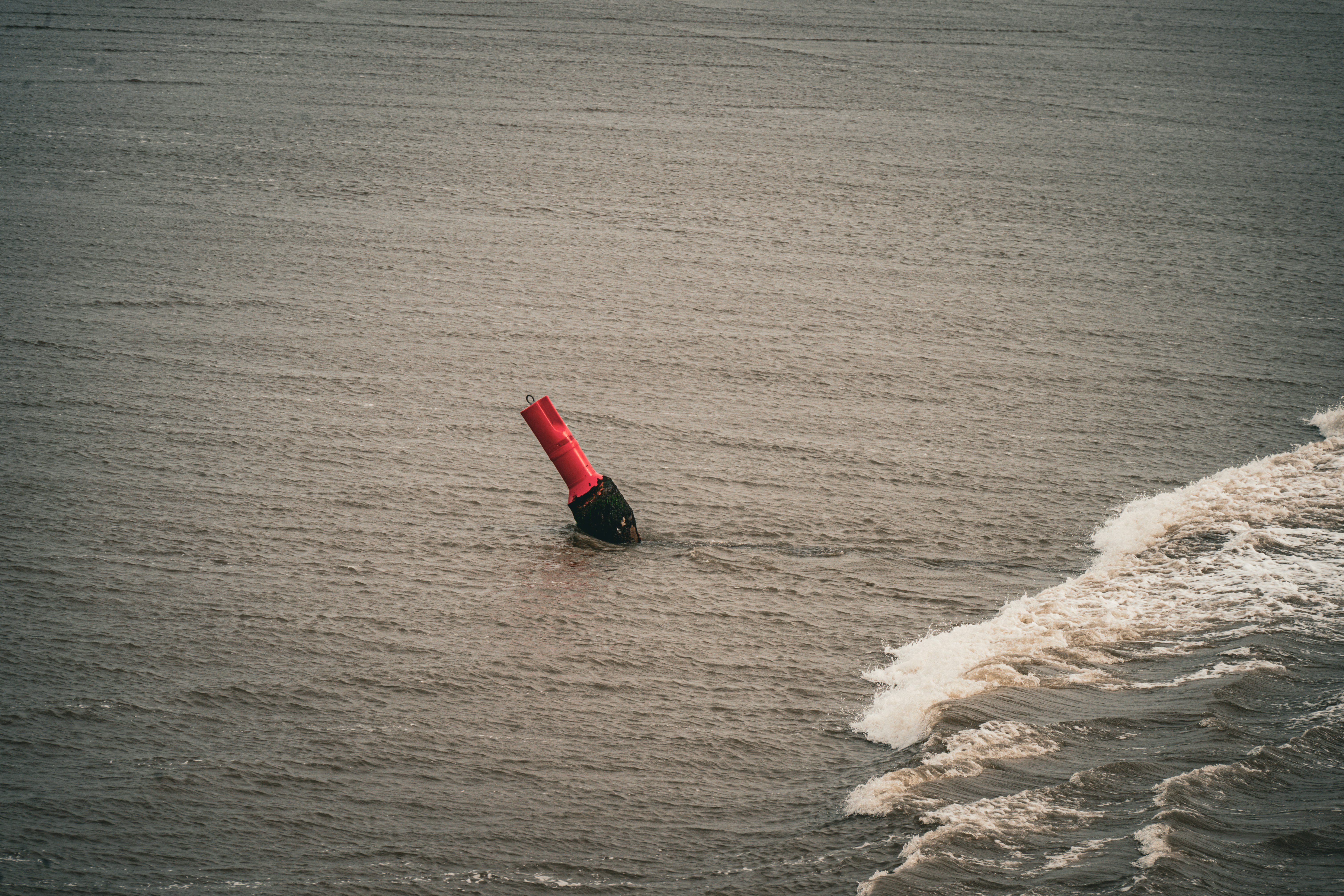 Red Buoy Drifting on Quiet Sea