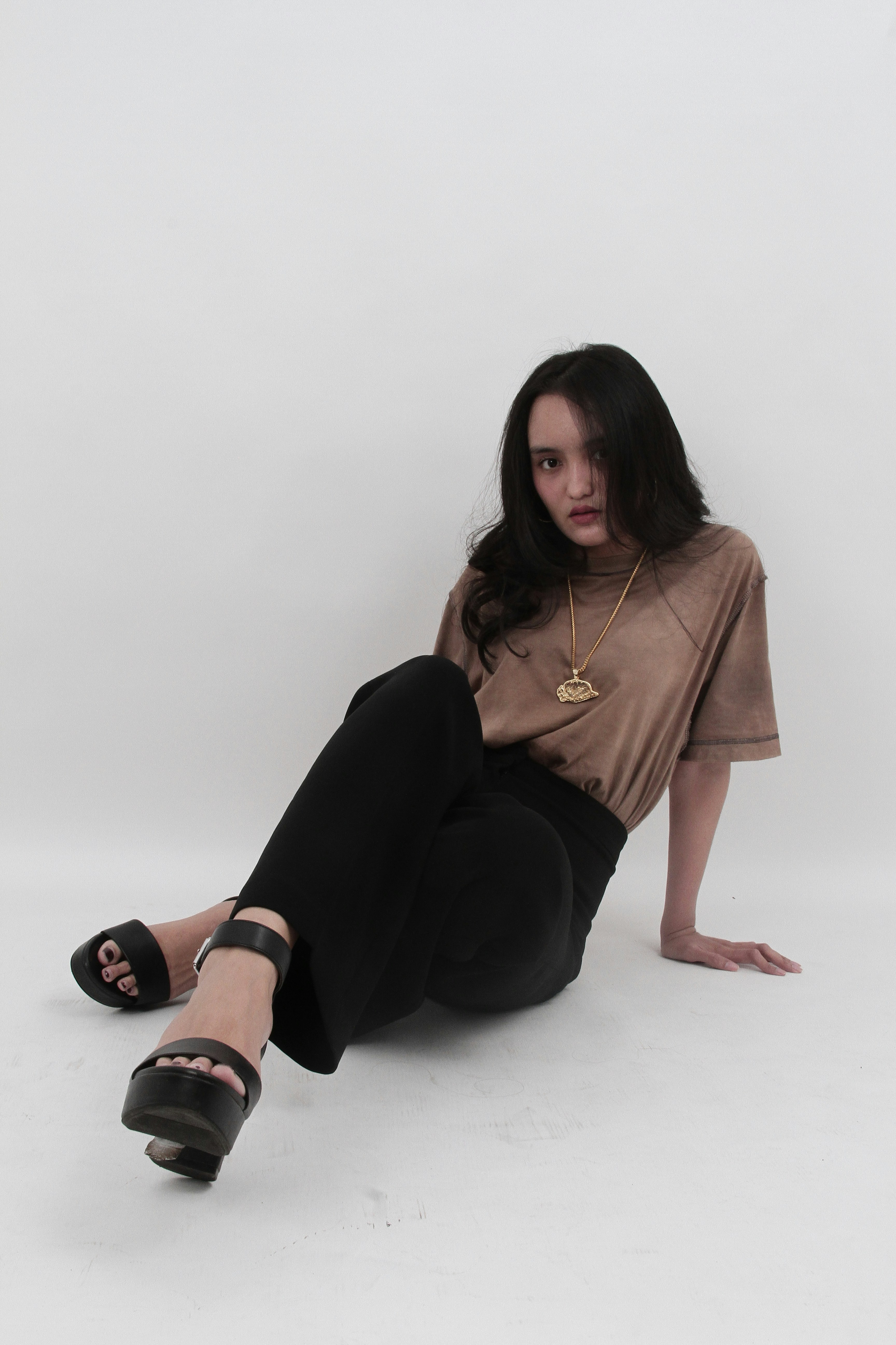 Relaxed Confidence: A Casual Studio Pose with Quiet Expression
