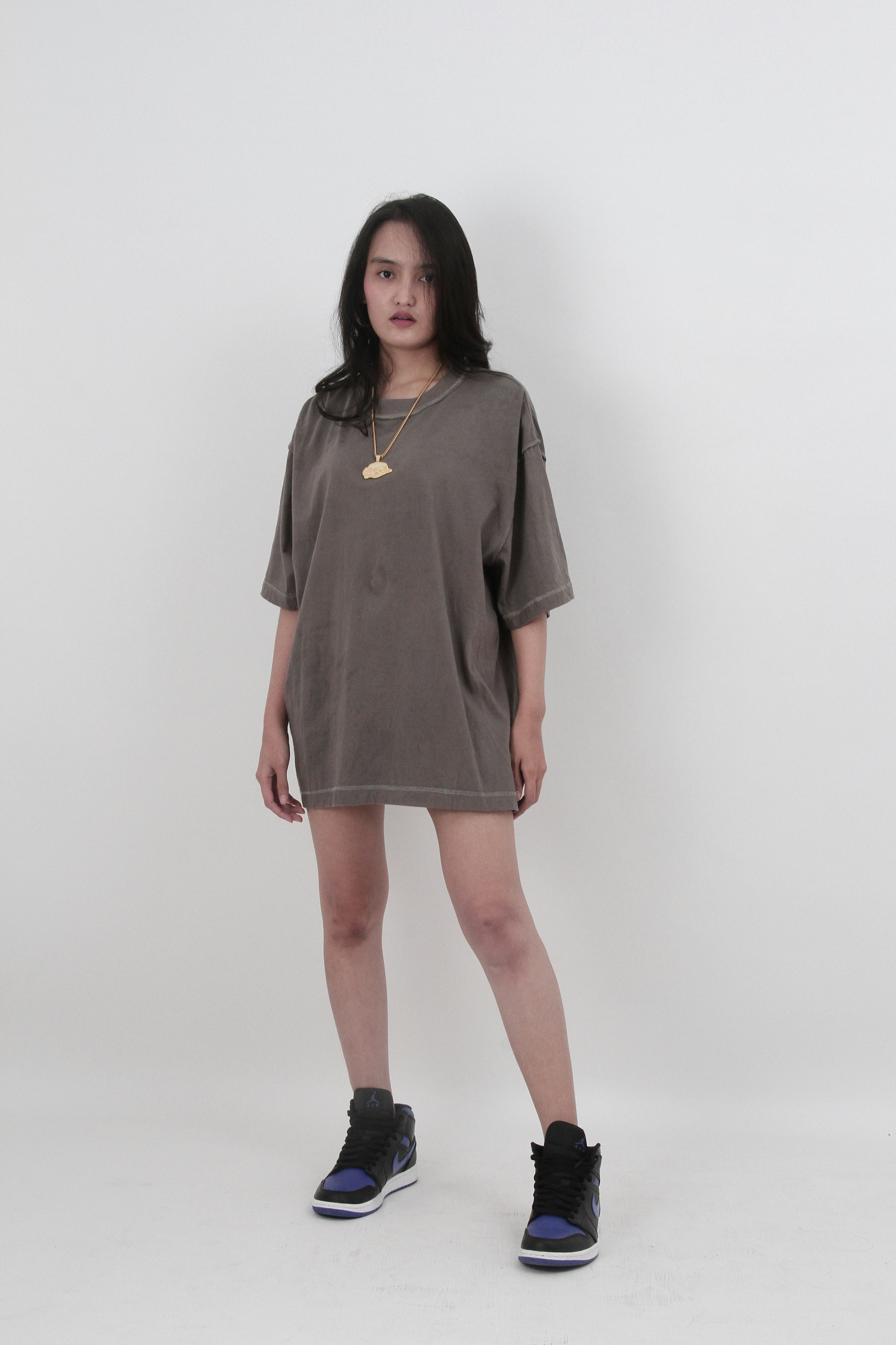 Taupe Oversized Tee, Neon-Soled Steps: A Quiet Studio Portrait