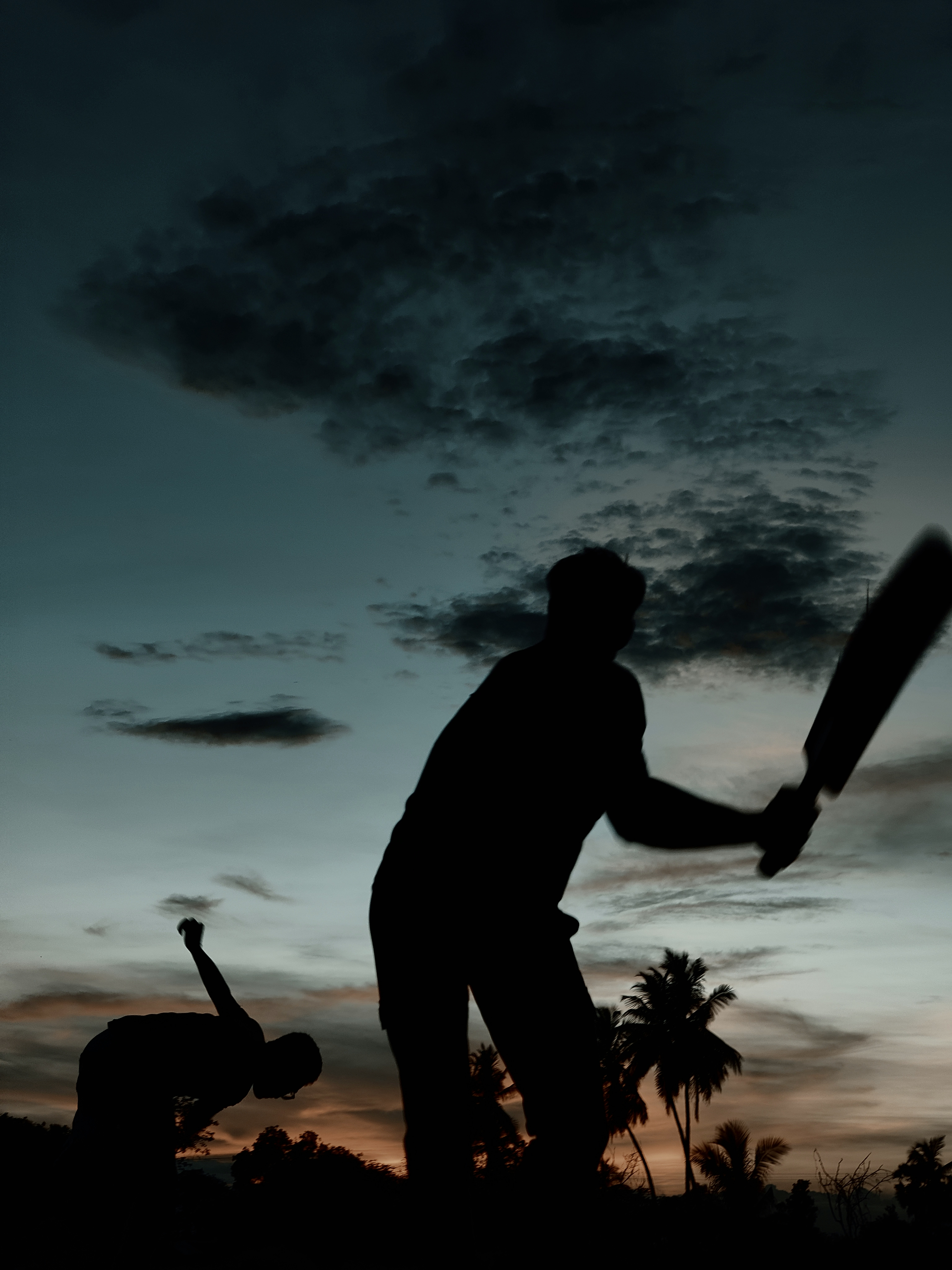 Silhouetted Batters at Dusk: A Quiet Clash of Shadows
