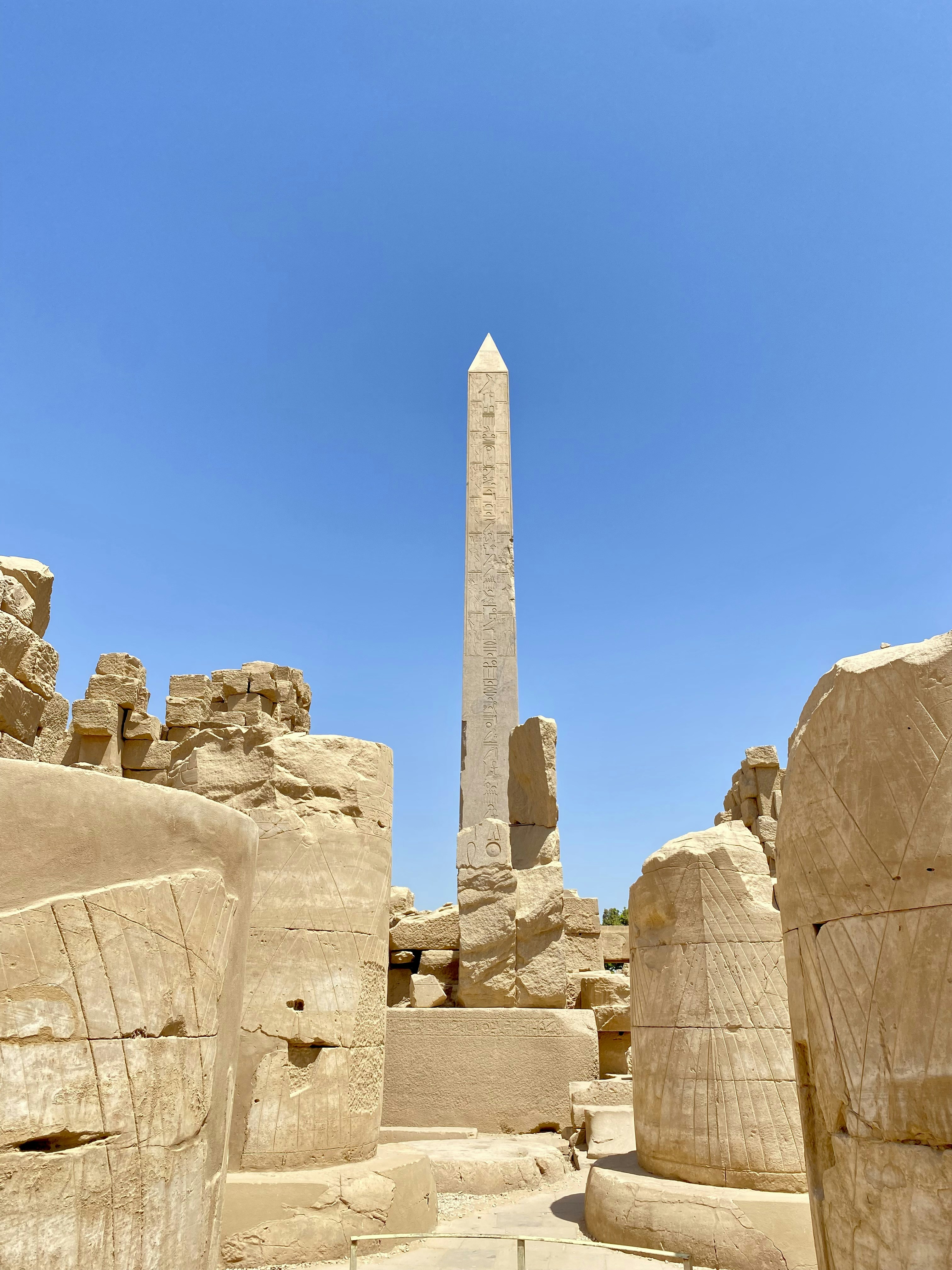 Stone Obelisk Rising Above An Ancient Court